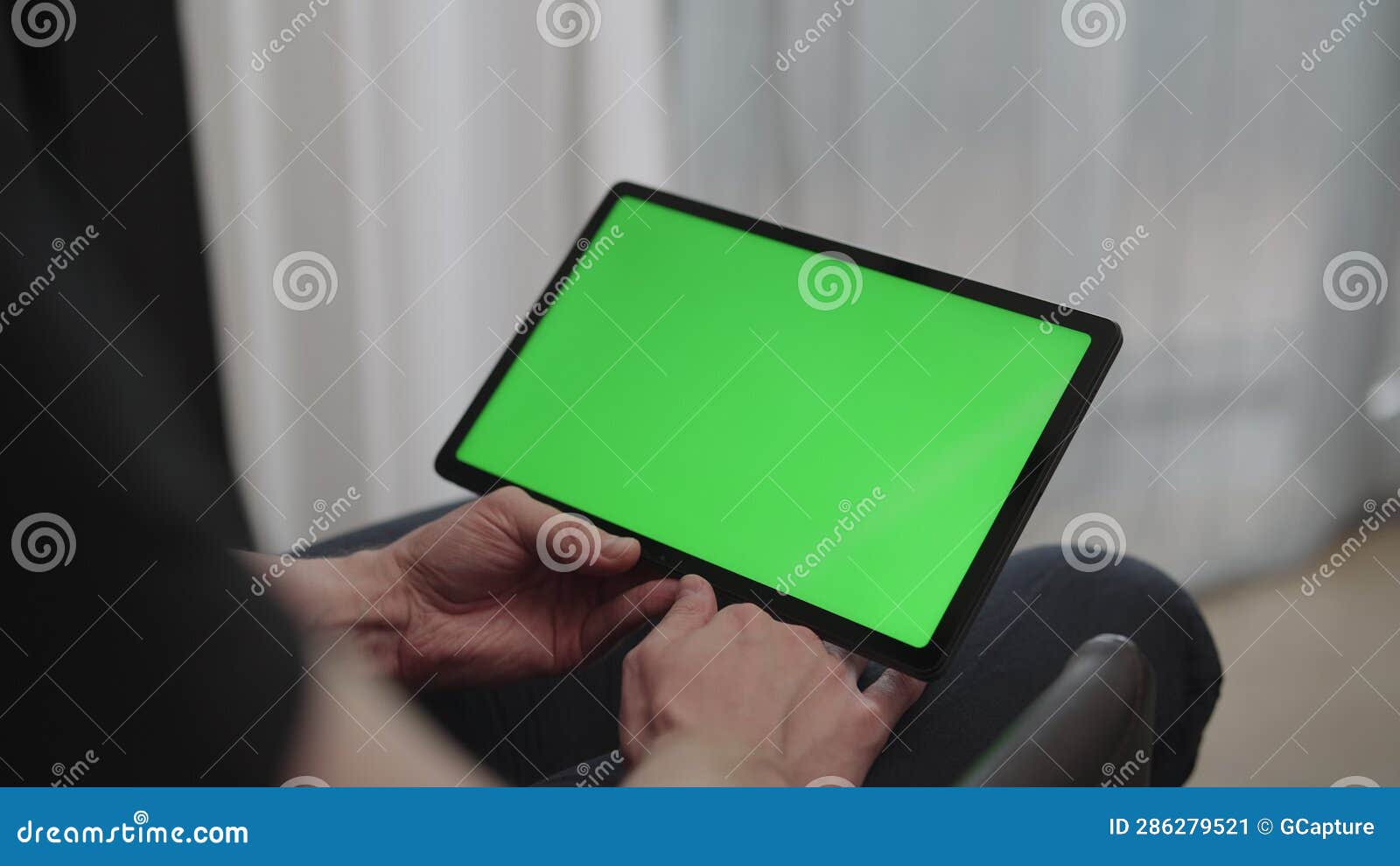 Man Sitting Indoors on a Chair with Tablet Pc with Green Screen Stock ...
