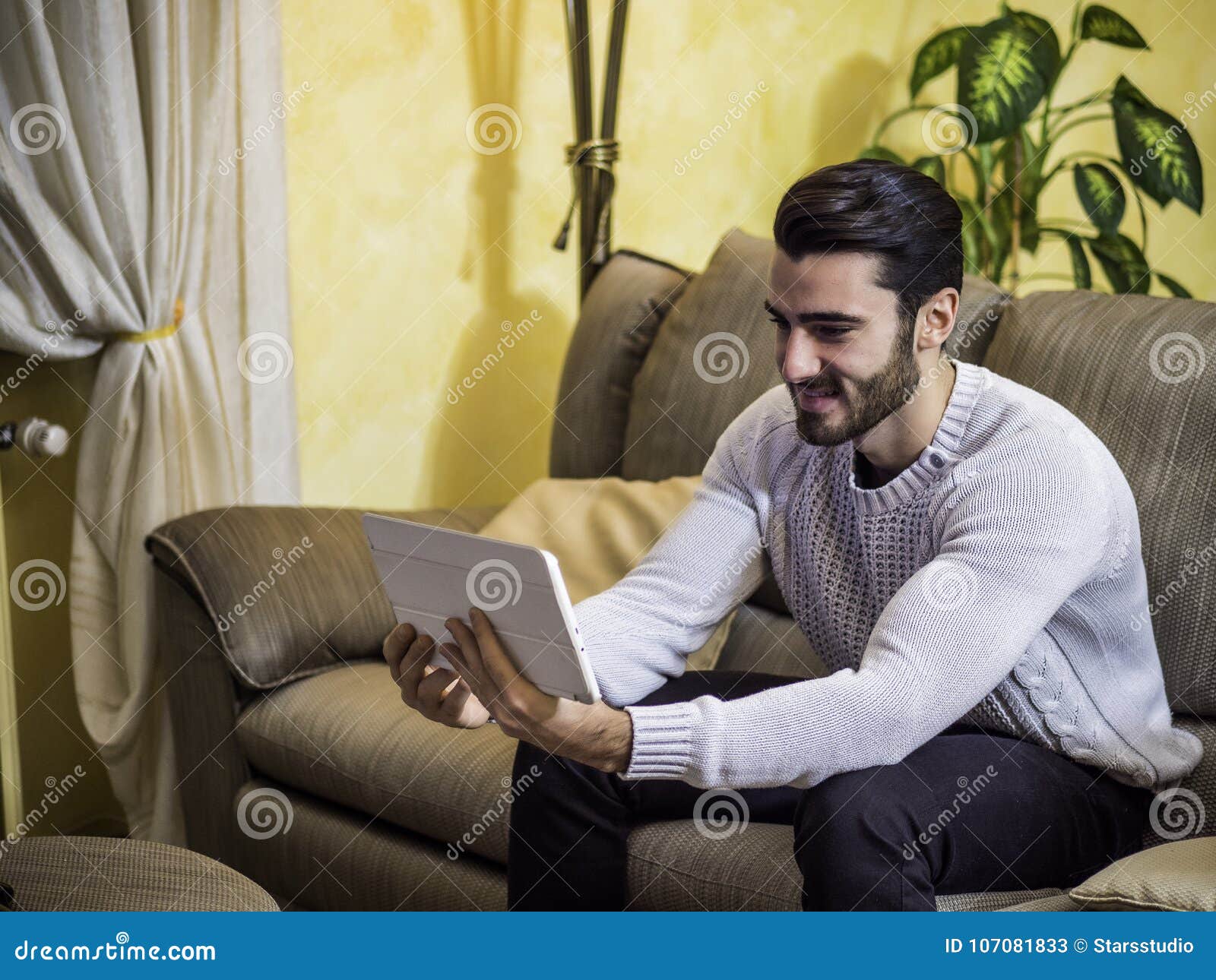 Man Sitting Indoors Video Chatting with Tablet PC Stock Image - Image ...