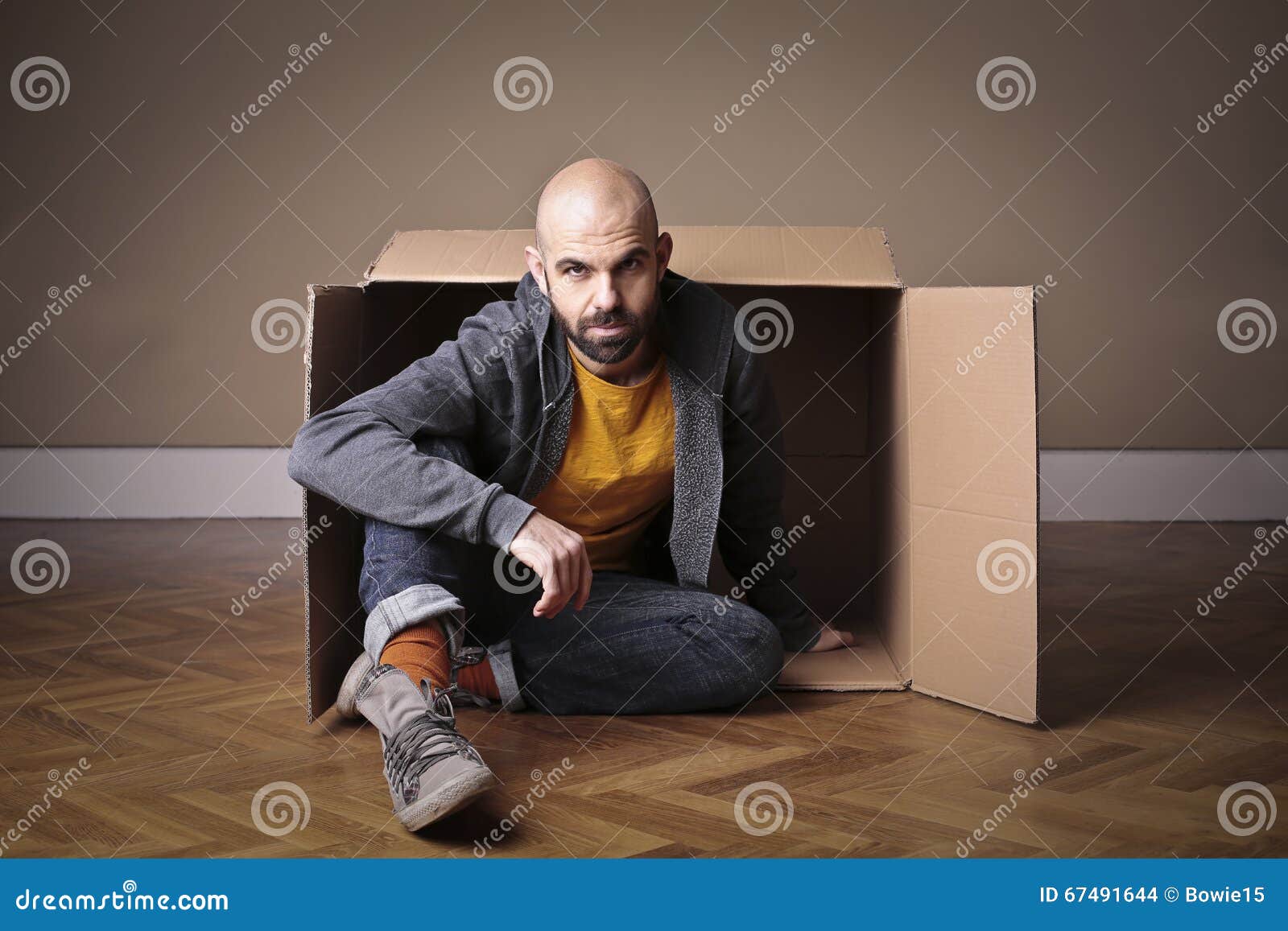 Man sitting inside a box stock photo. Image of work, cardboard - 67491644