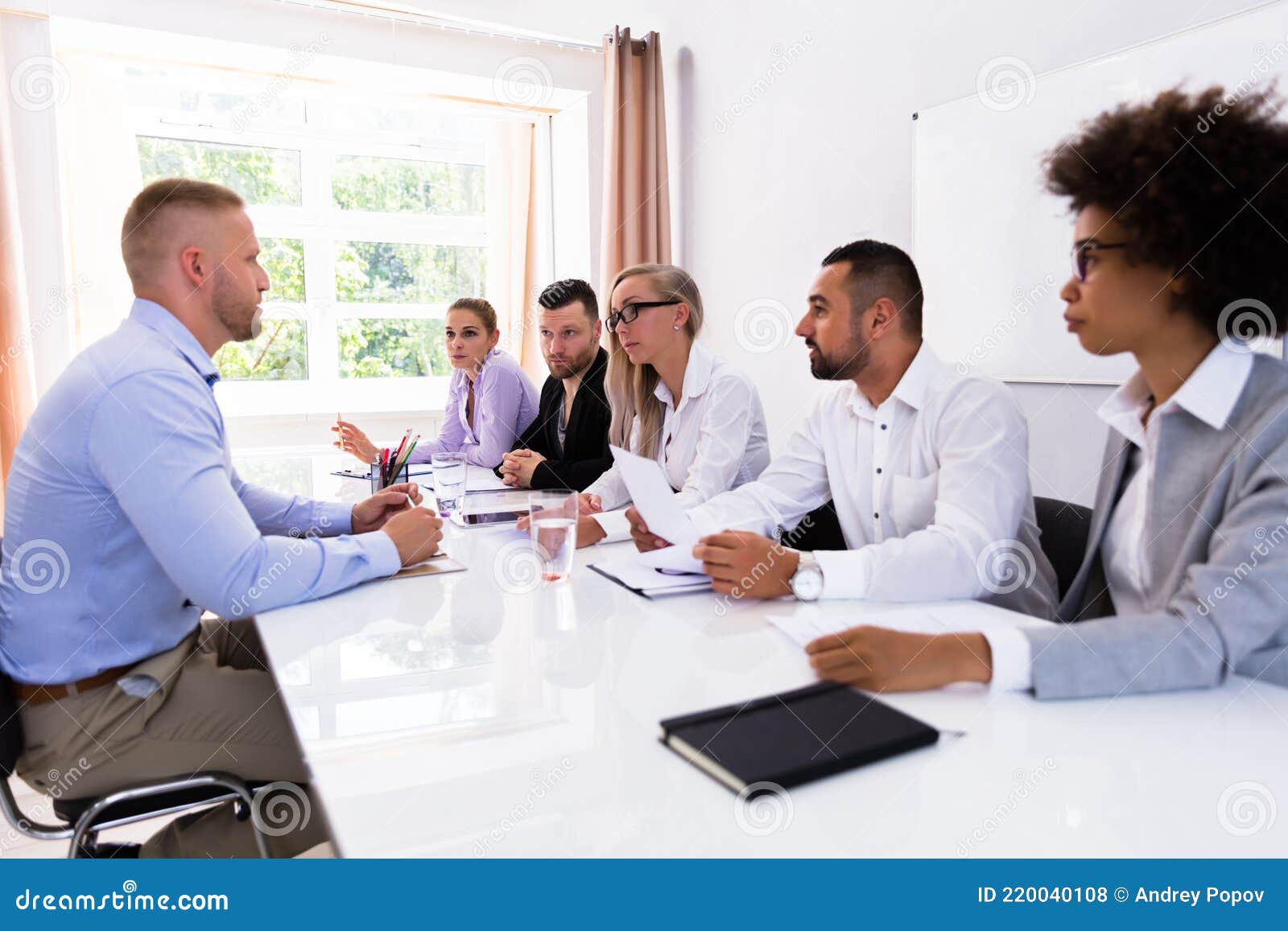 Man Sitting at Interview stock photo. Image of meeting - 220040108