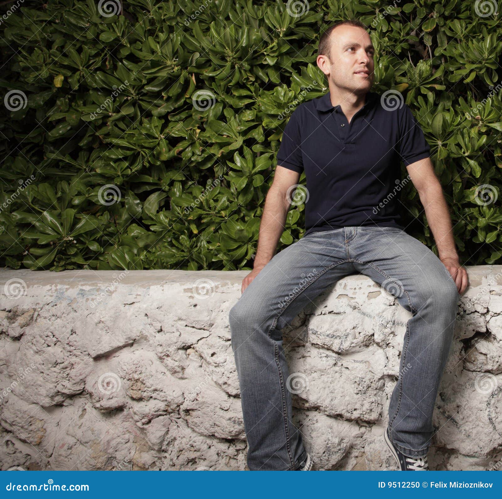 Man sitting on a ledge stock photo. Image of glance, polo - 9512250