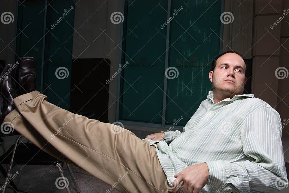 Man sitting with legs up stock image. Image of handsome - 6983729