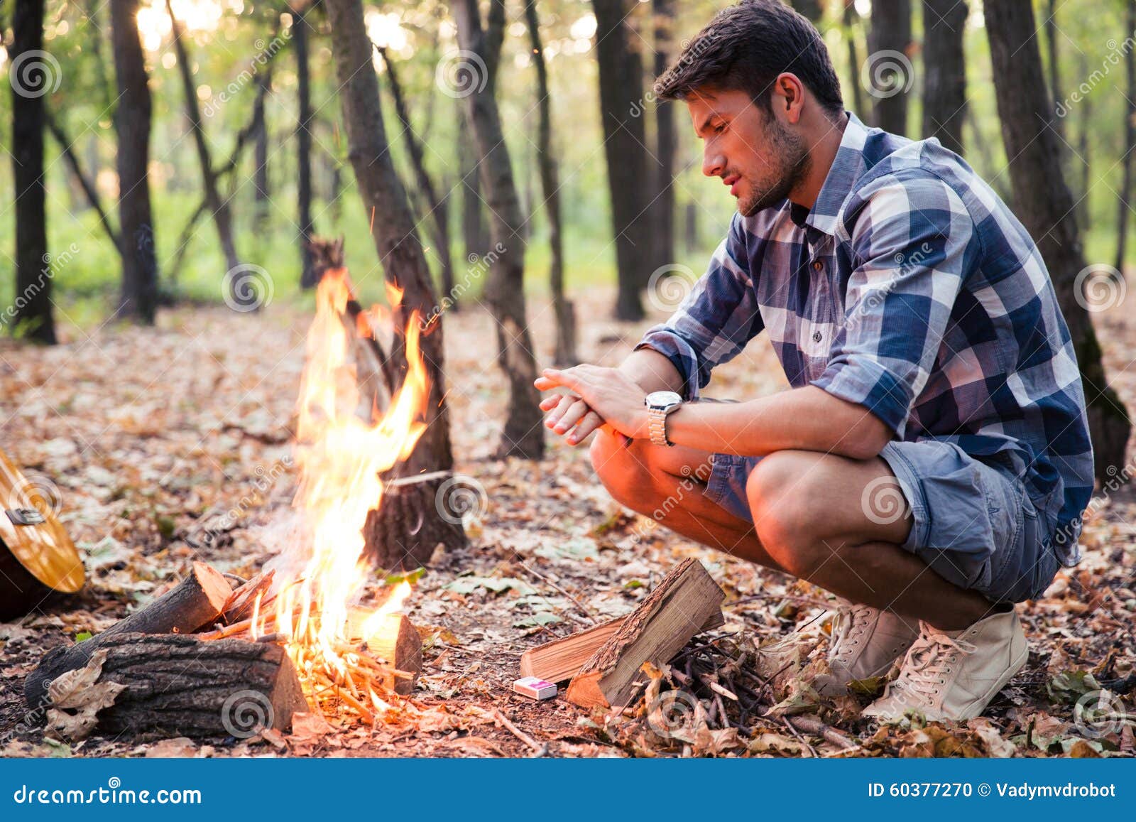Man Sitting Near Bonfire in the Forest Stock Photo - Image of flare ...