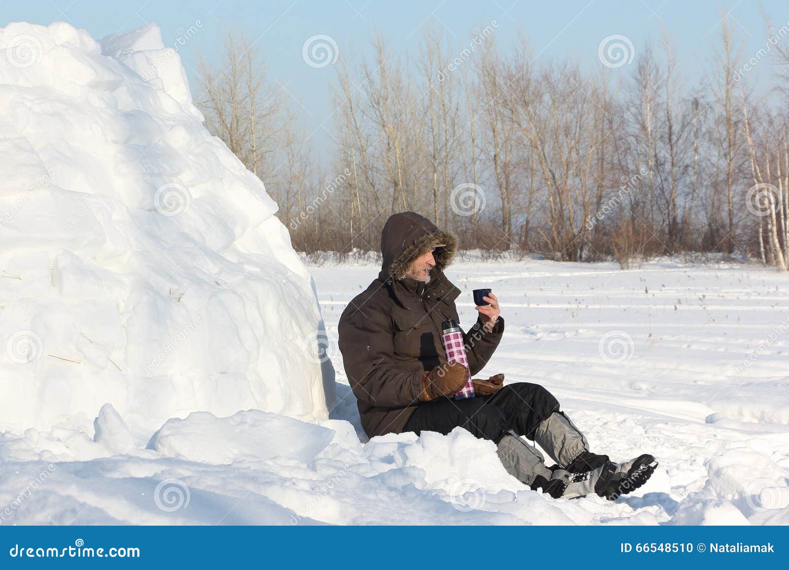 The Man Sitting Near an Igloo and Drinking Tea from Thermos Stock Photo ...