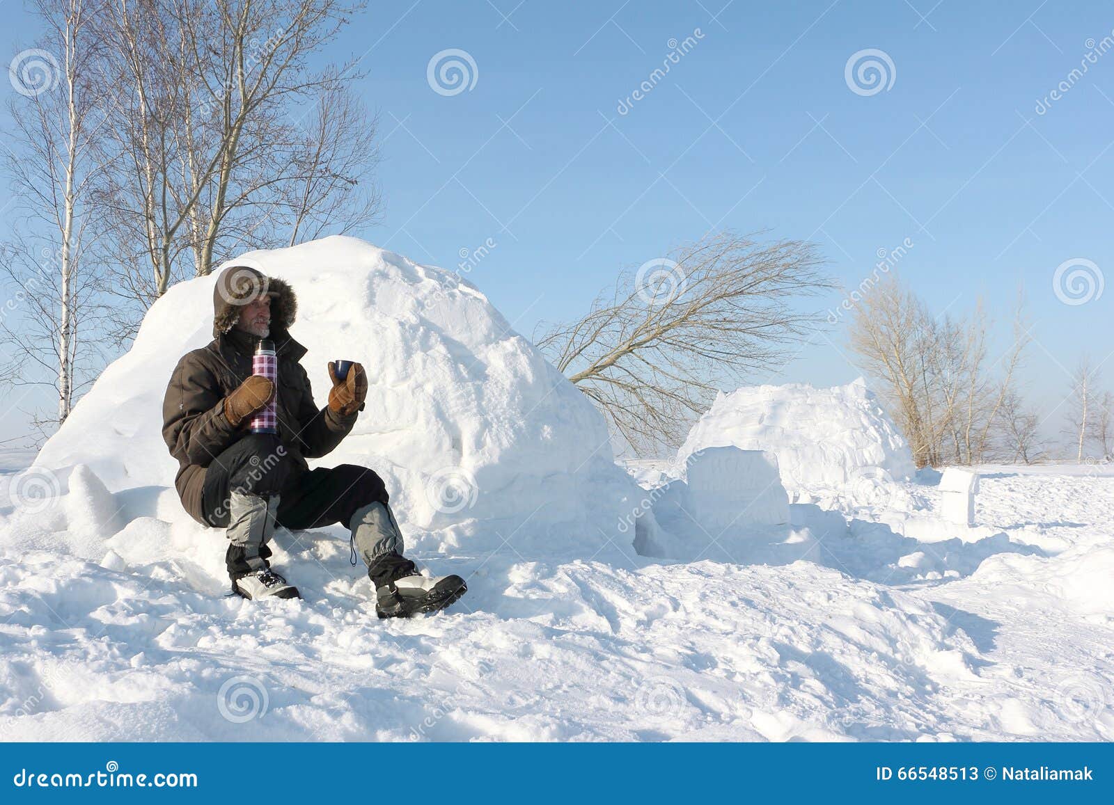 The Man Sitting Near an Igloo and Drinking Tea from Thermos Stock Image ...