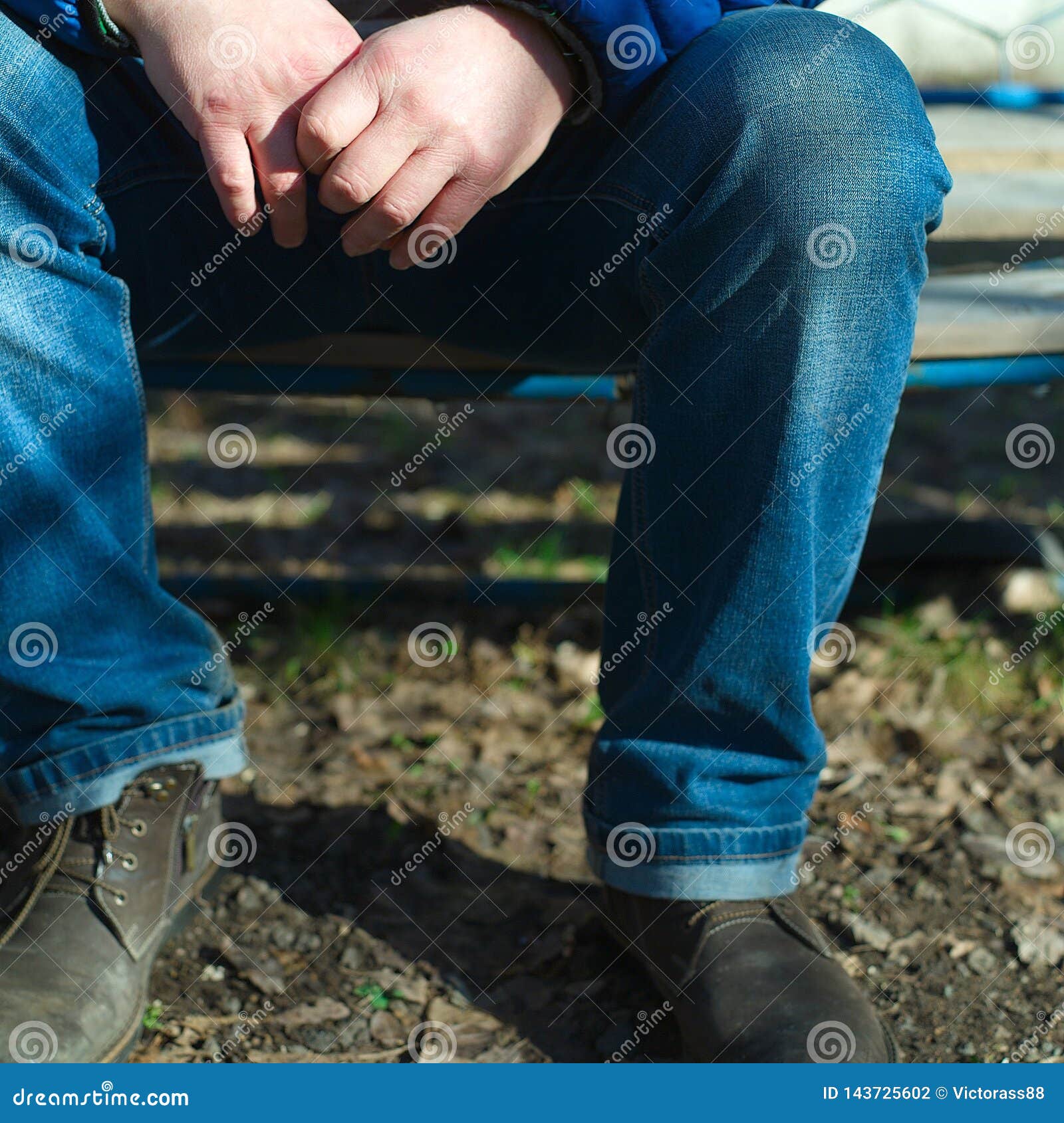 Man sitting outdoor stock photo. Image of wear, legs - 143725602