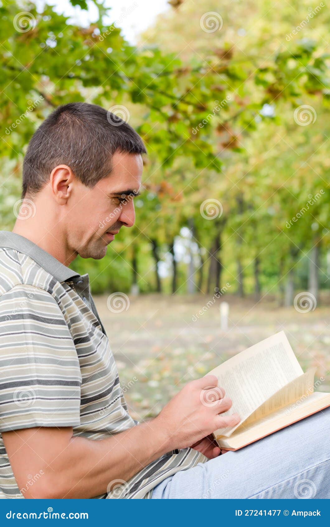 Man Sitting Outdoors Reading a Novel Stock Image - Image of profile ...