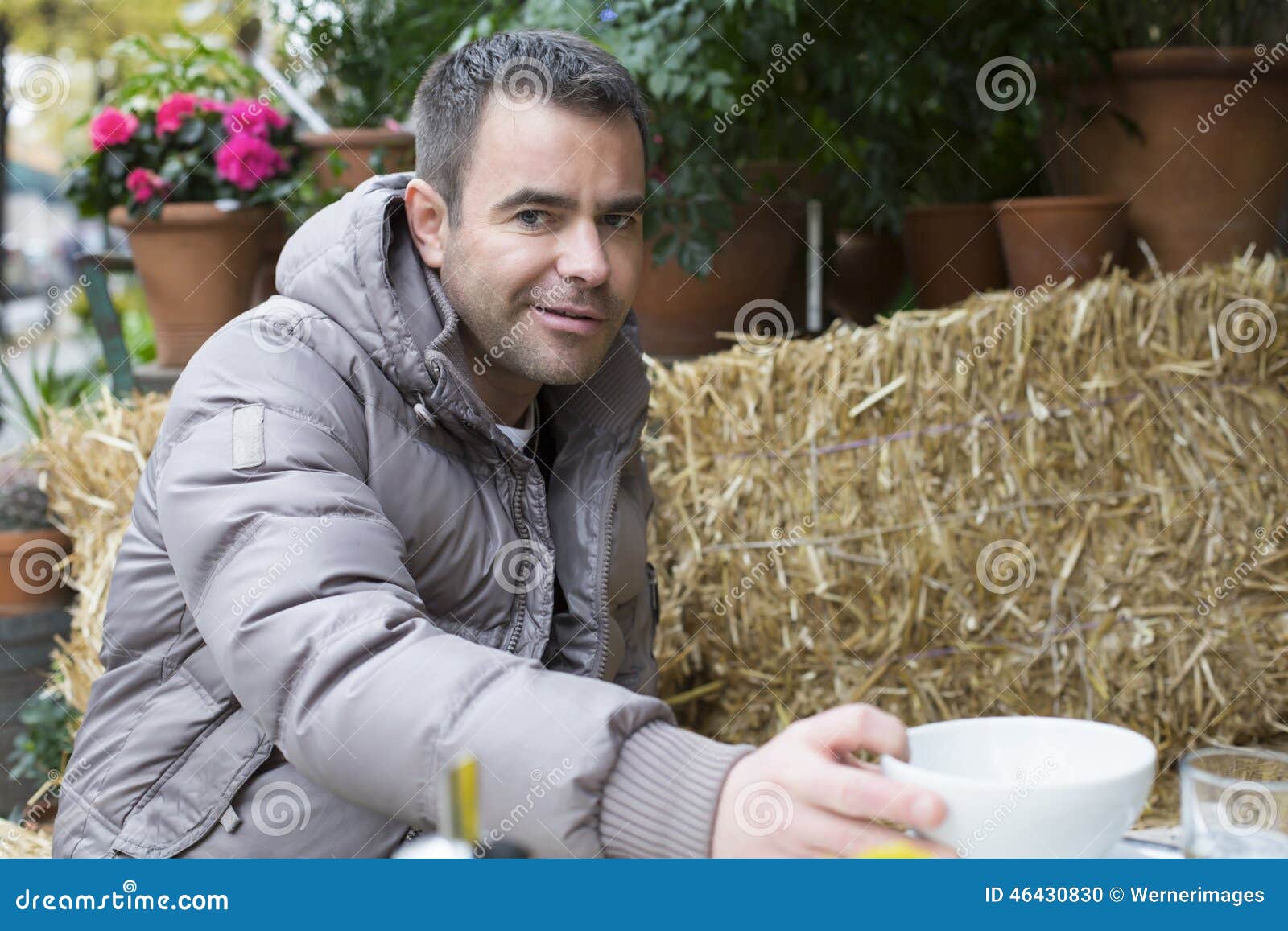 Man Sitting Outside with a Cup in His Hands Stock Photo - Image of ...