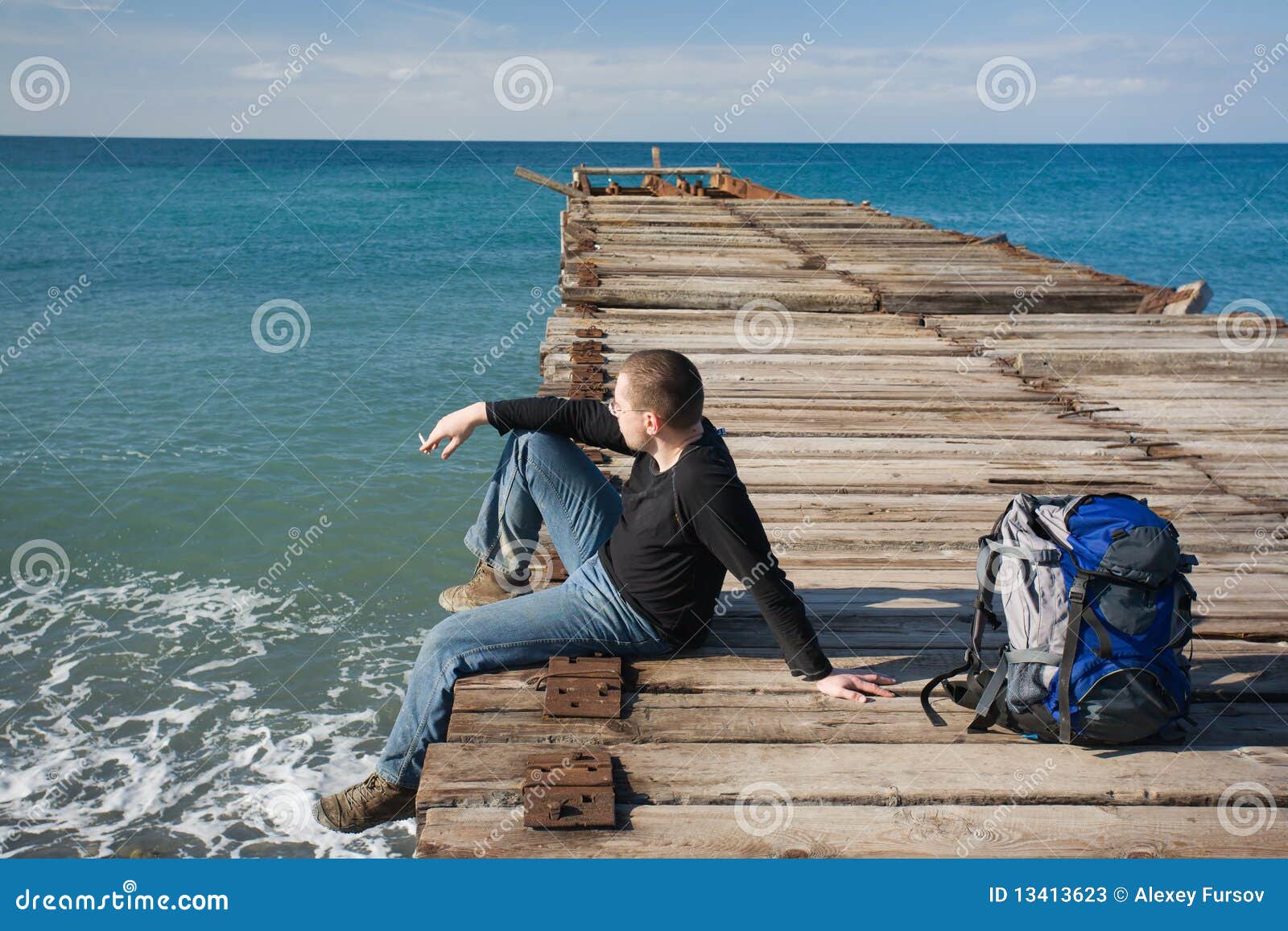 Man sitting at pier stock image. Image of moorage, light - 13413623