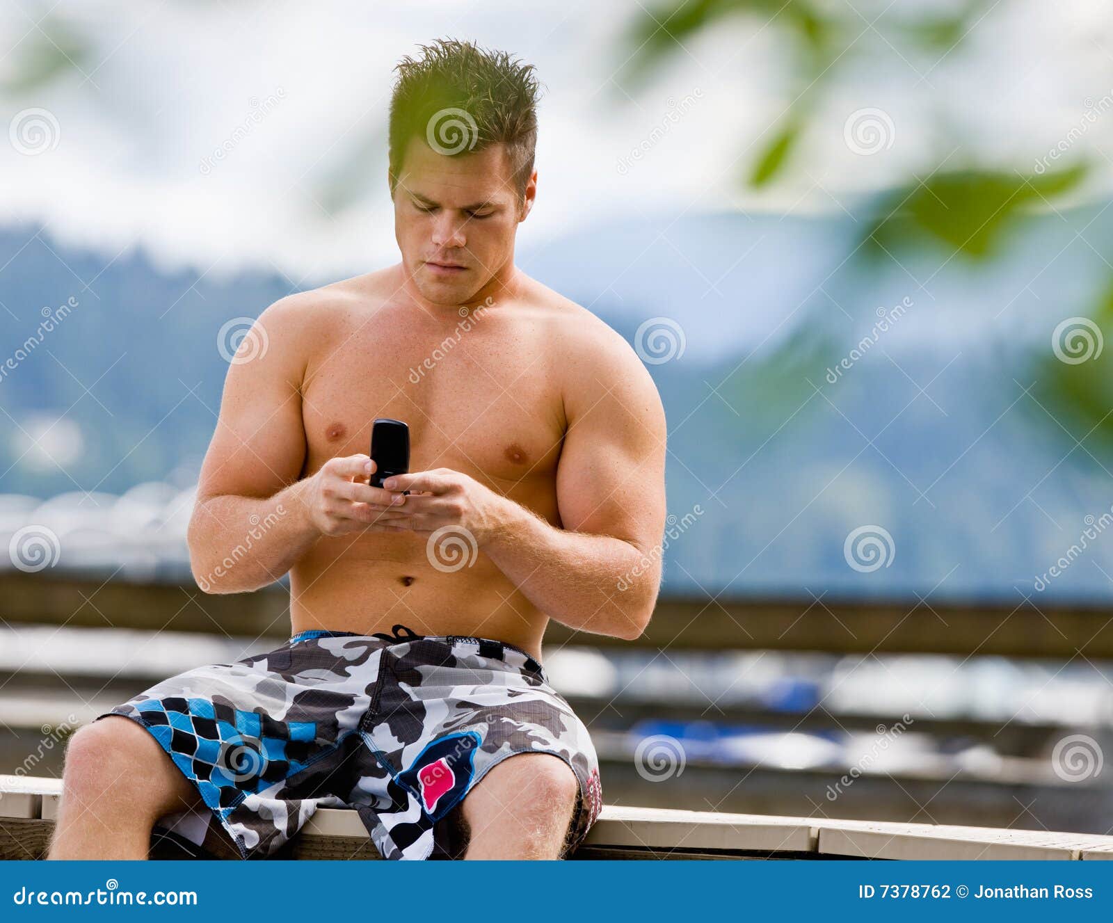 Man Sitting on Pier Text Messaging Stock Photo - Image of communicating ...
