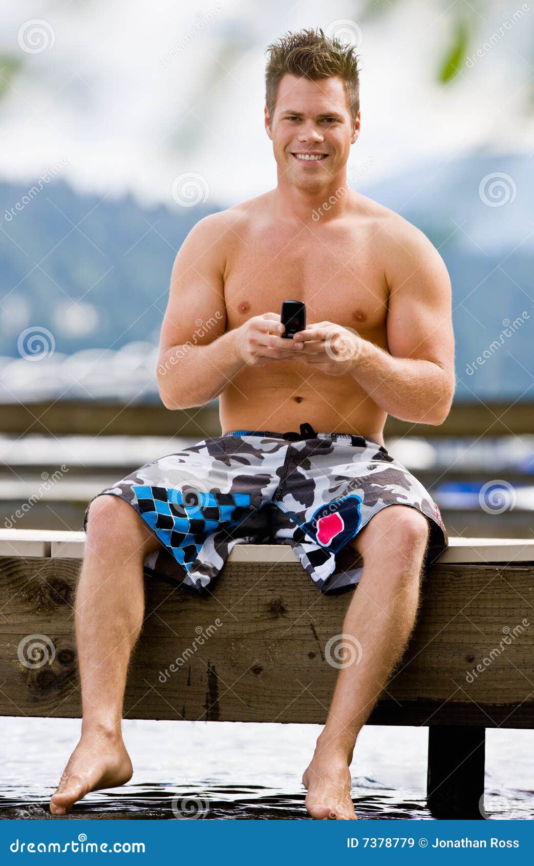 Man Sitting on Pier Text Messaging Stock Image - Image of resting ...