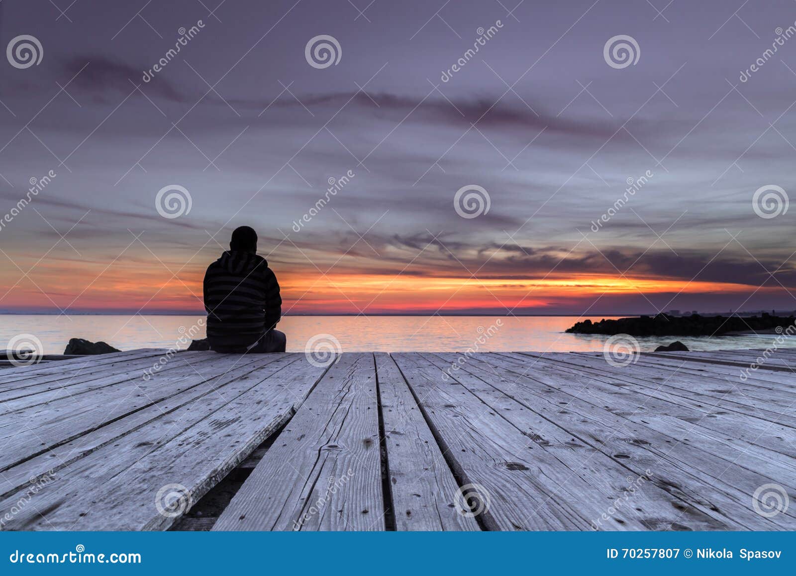 Man Sitting on the Pier and Watching the Sunset Stock Image - Image of ...