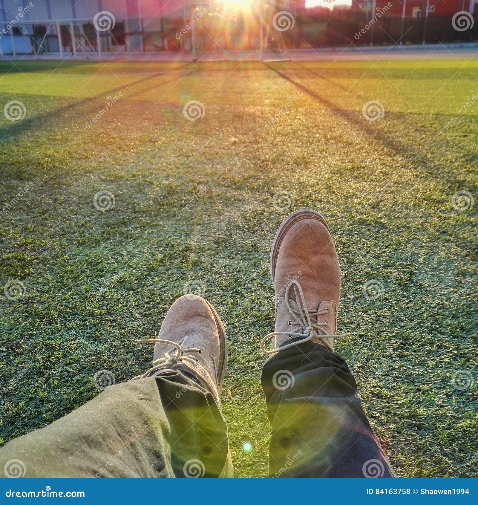 Man sitting on playground stock photo. Image of grassland - 84163758