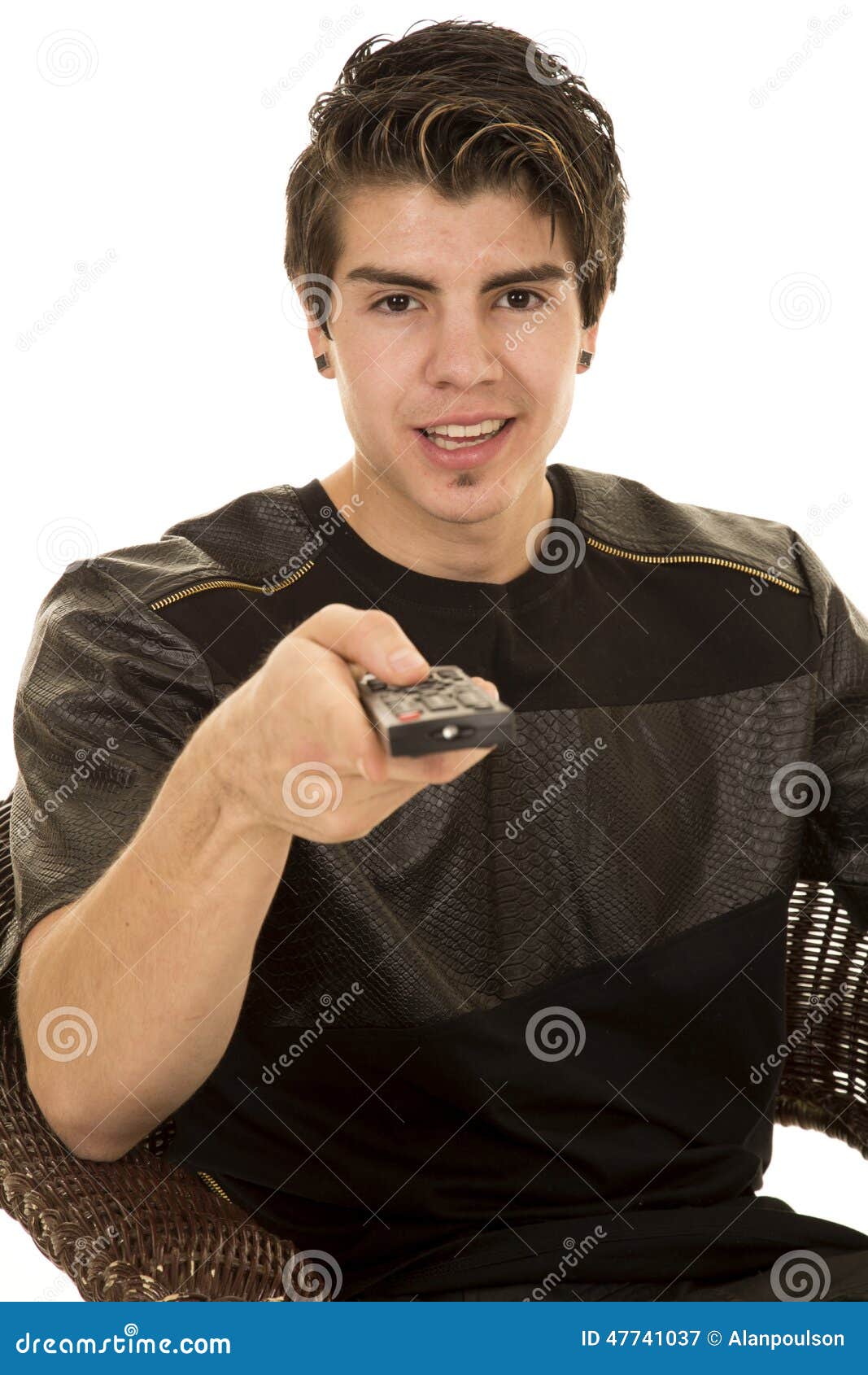 A Man Sitting Pointing a Remote Control Smiling Stock Image - Image of ...