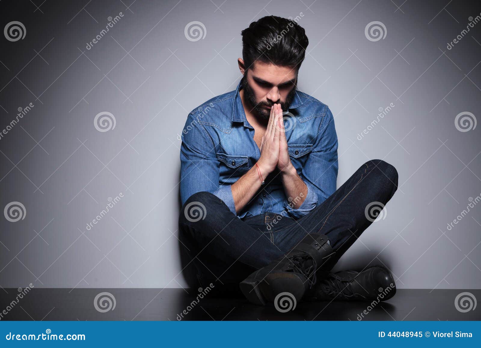 Man sitting and praying stock image. Image of beard, seated - 44048945