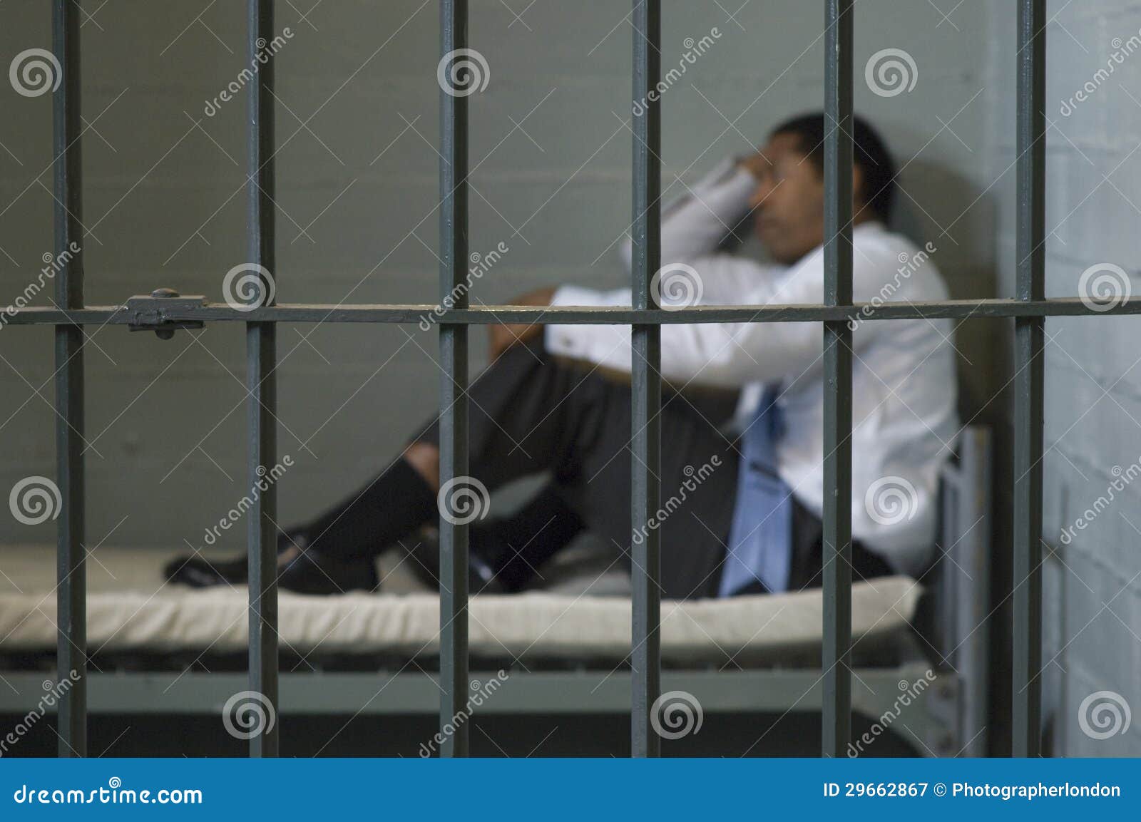 Man Sitting in Prison Cell stock image. Image of imprisoned - 29662867