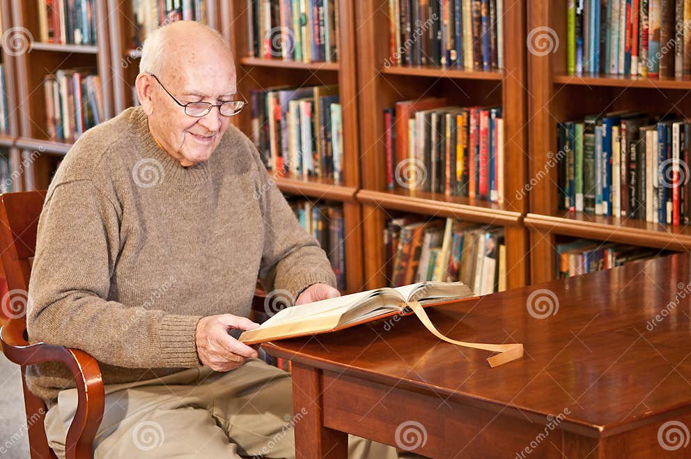 Man Sitting and Reading Book at Library Table Stock Image - Image of ...