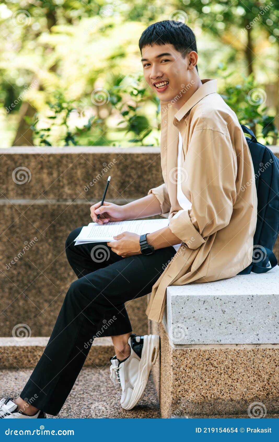 A Man Sitting and Reading a Book on the Stairs Stock Photo - Image of ...