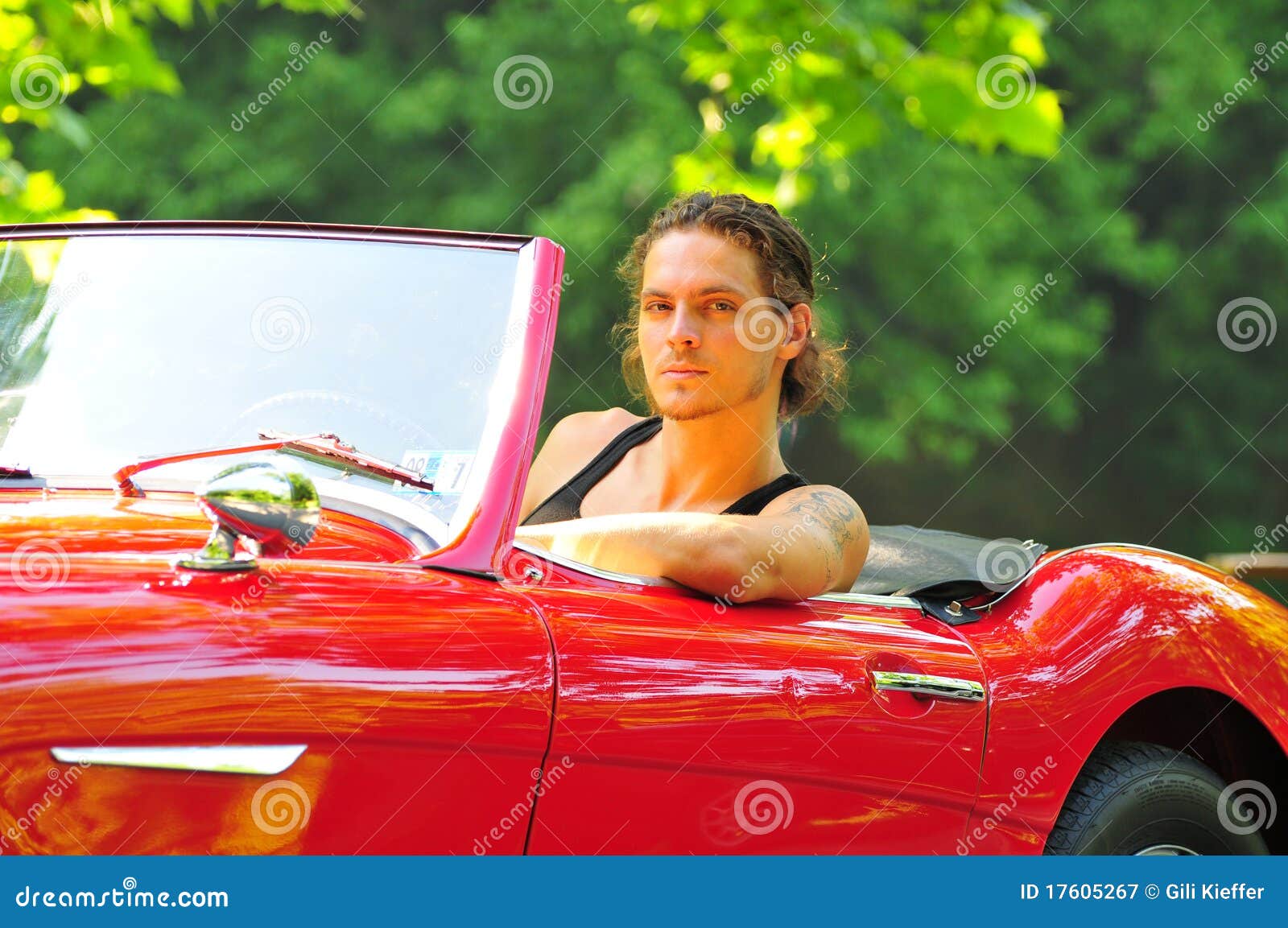 Man sitting in a red car stock image. Image of convertible - 17605267