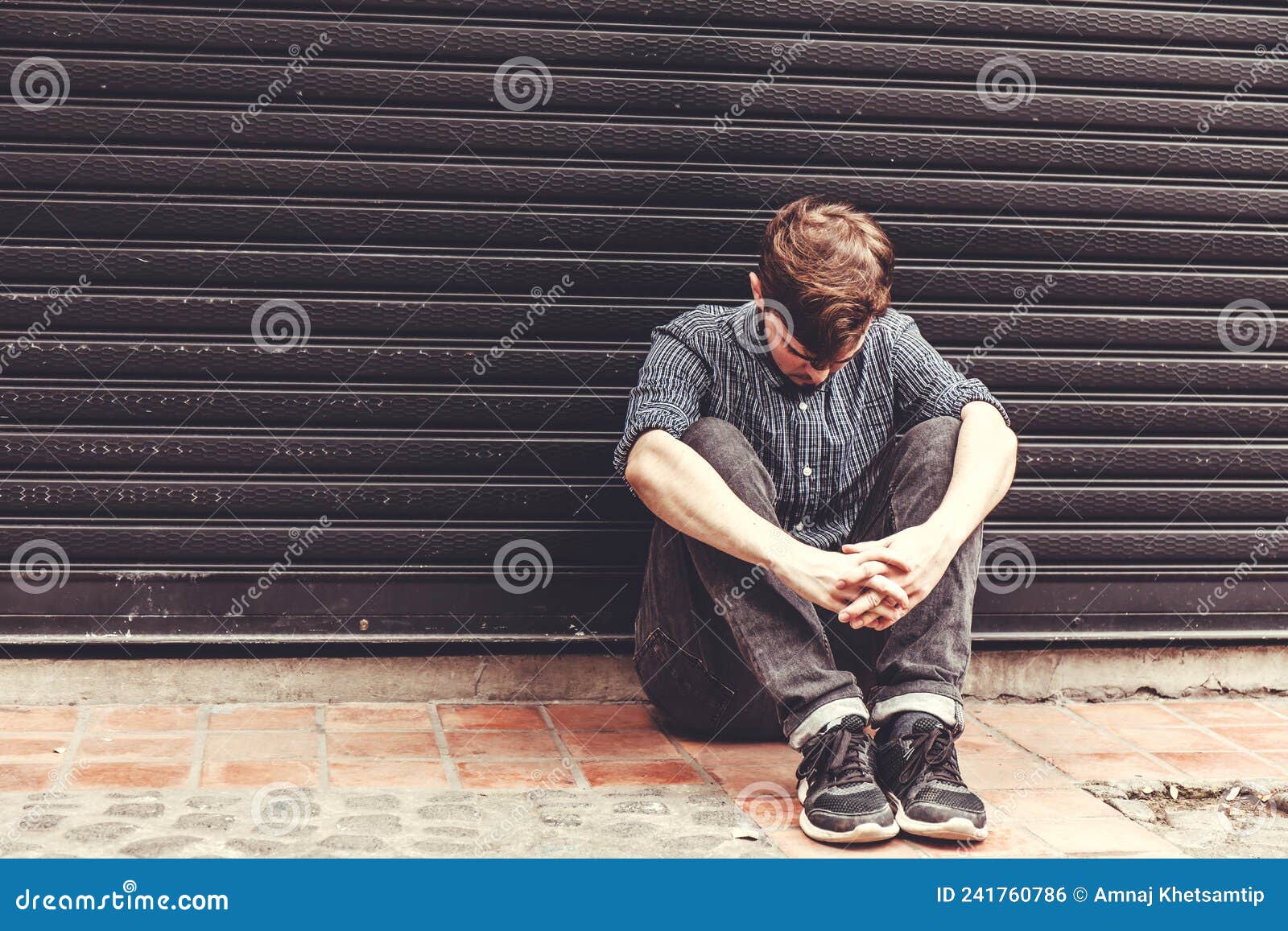 A Man sitting sad alone stock photo. Image of loss, alone - 241760786