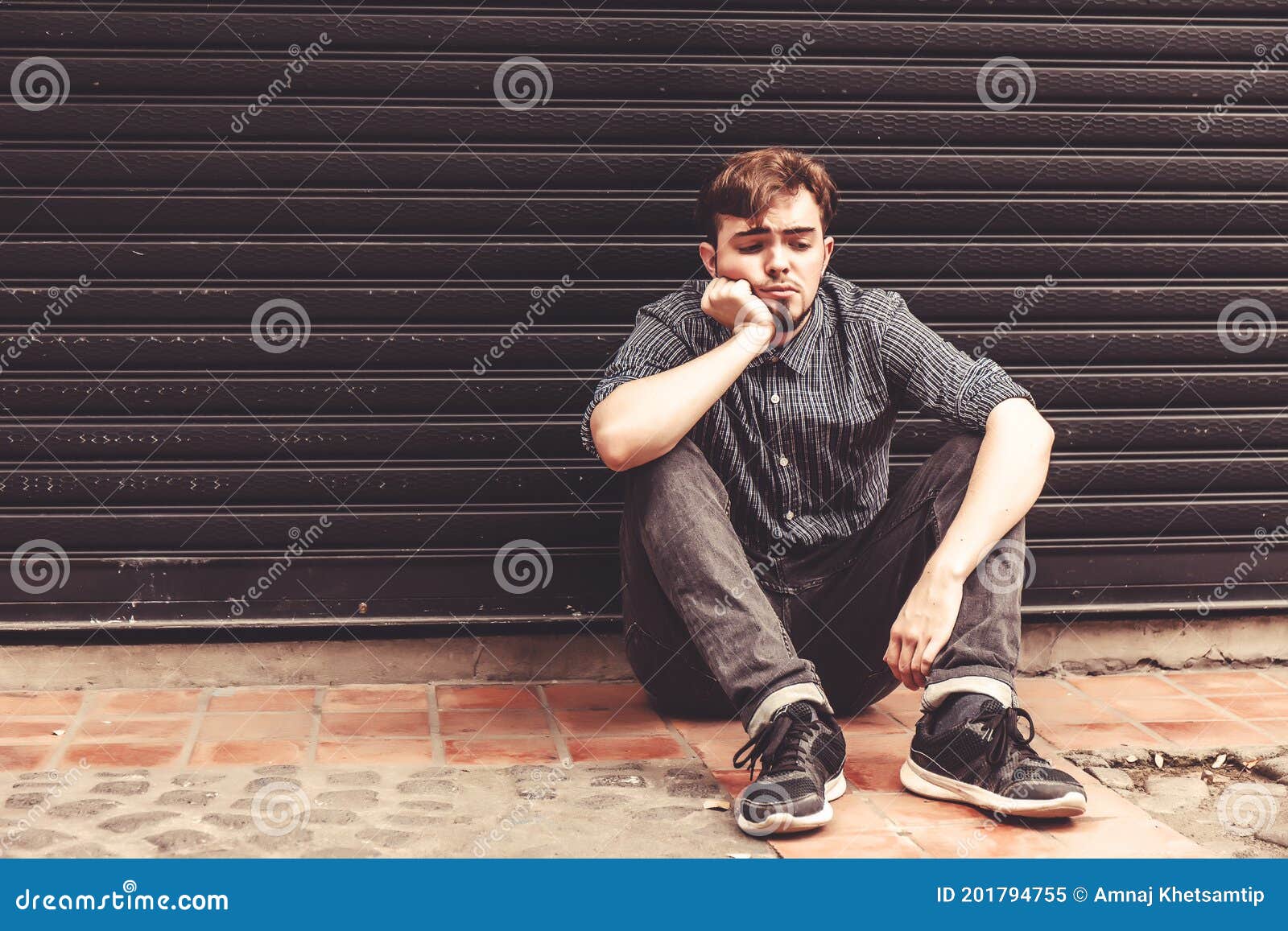 Man sitting sad alone stock image. Image of confusion - 201794755