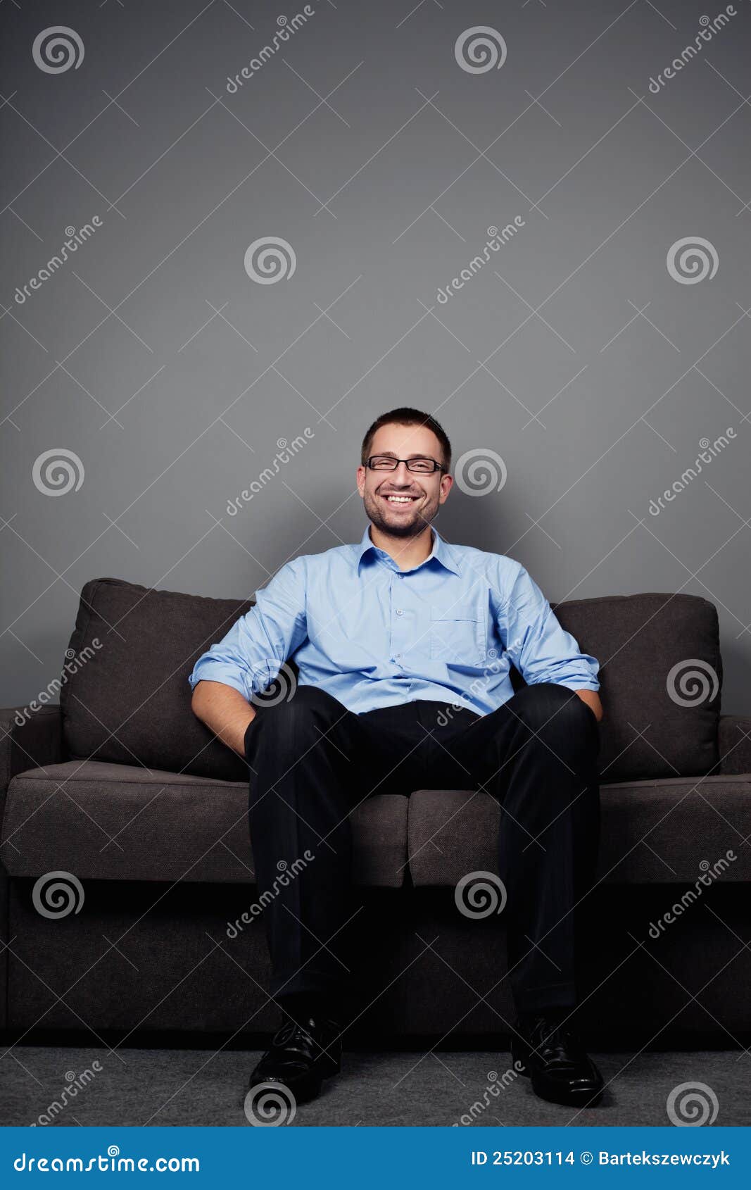Man sitting on sofa stock photo. Image of professional - 25203114
