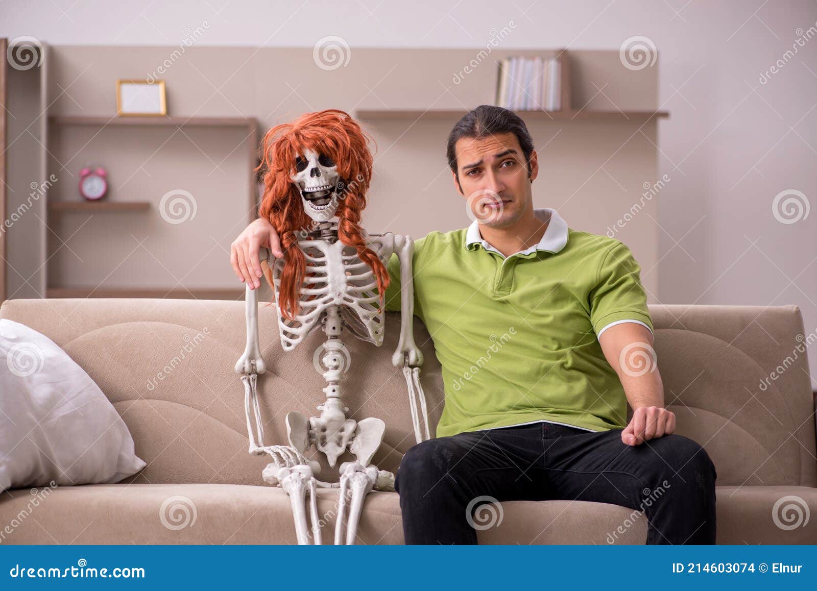Young Man Sitting on the Sofa with Female Skeleton Stock Photo - Image ...