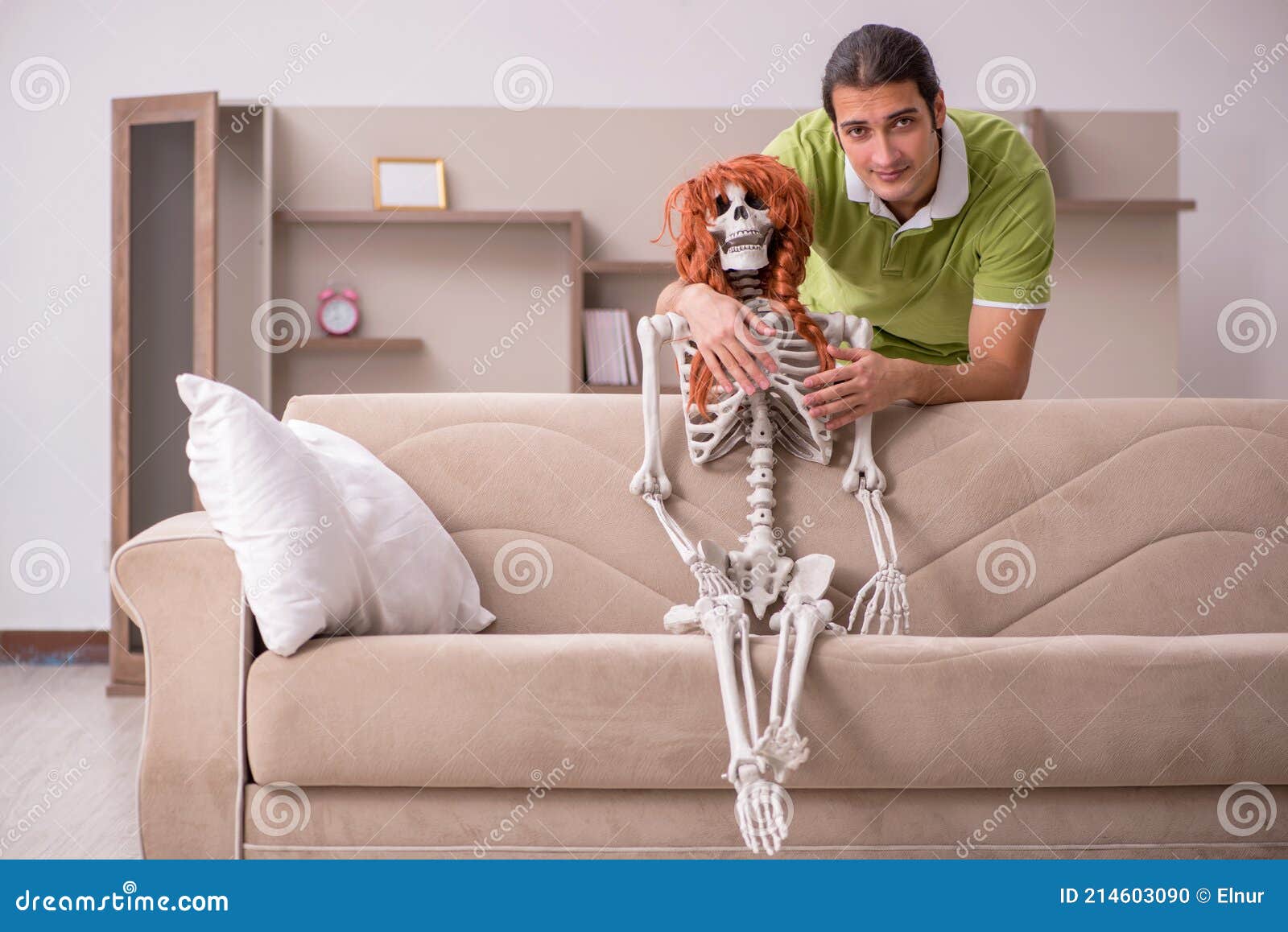 Young Man Sitting on the Sofa with Female Skeleton Stock Photo - Image ...