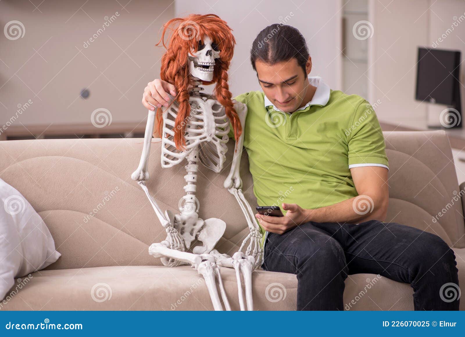 Young Man Sitting on the Sofa with Female Skeleton Stock Image - Image ...