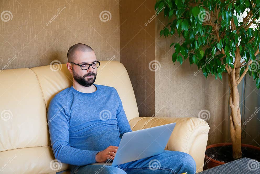 Man Sitting on the Sofa with Laptop Stock Photo - Image of notebook ...