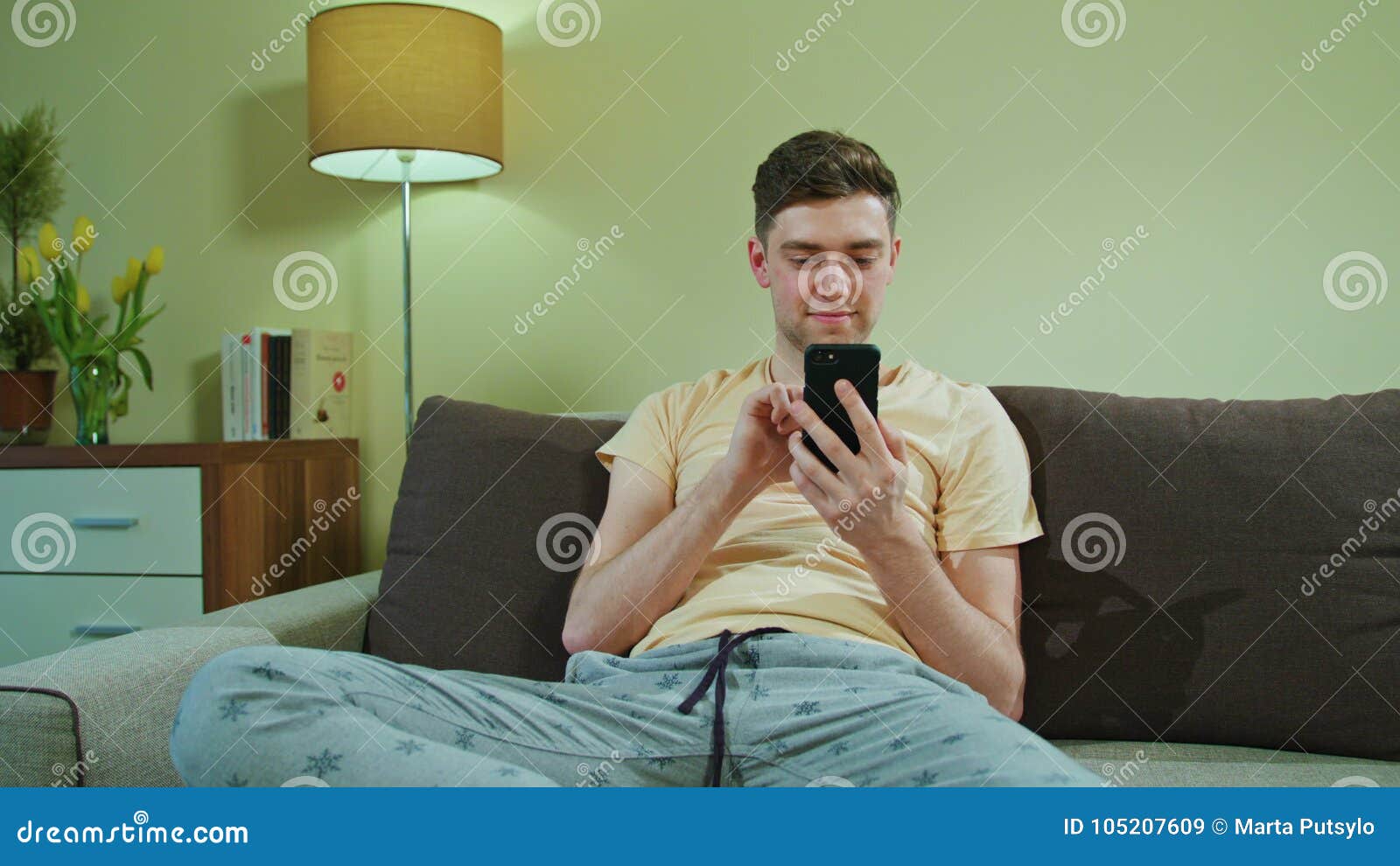 Man Sitting on the Sofa and Using Mobile Phone Stock Image - Image of ...