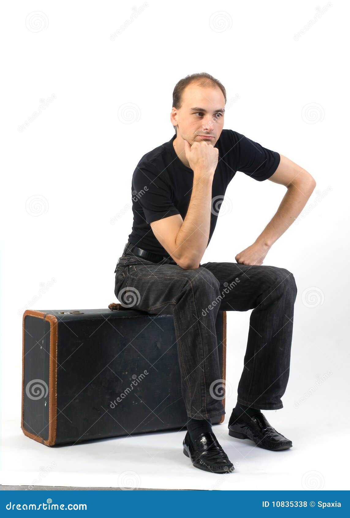 Man sitting on suitcase stock photo. Image of traveler - 10835338