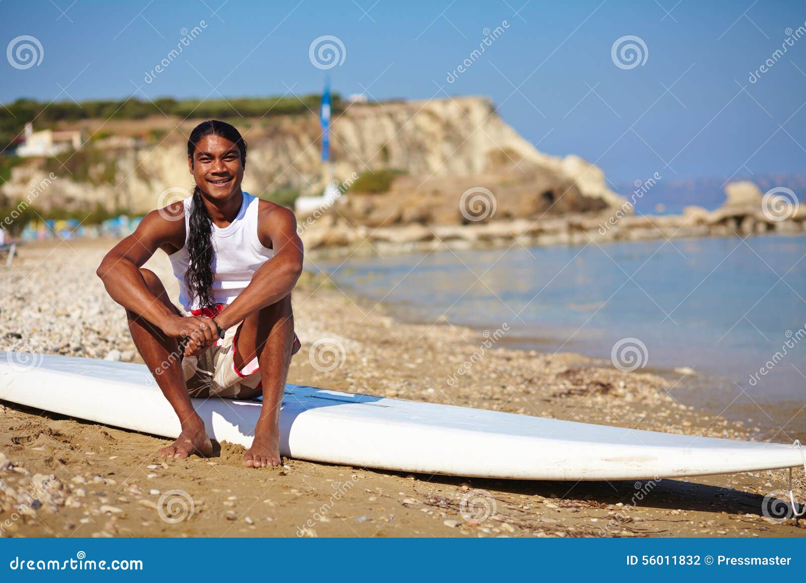 Man sitting on surfboard stock photo. Image of resort - 56011832