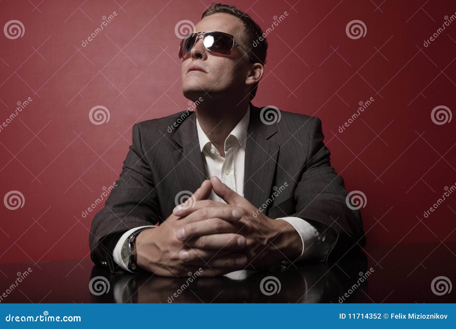 Man sitting on a table stock photo. Image of sunglasses - 11714352