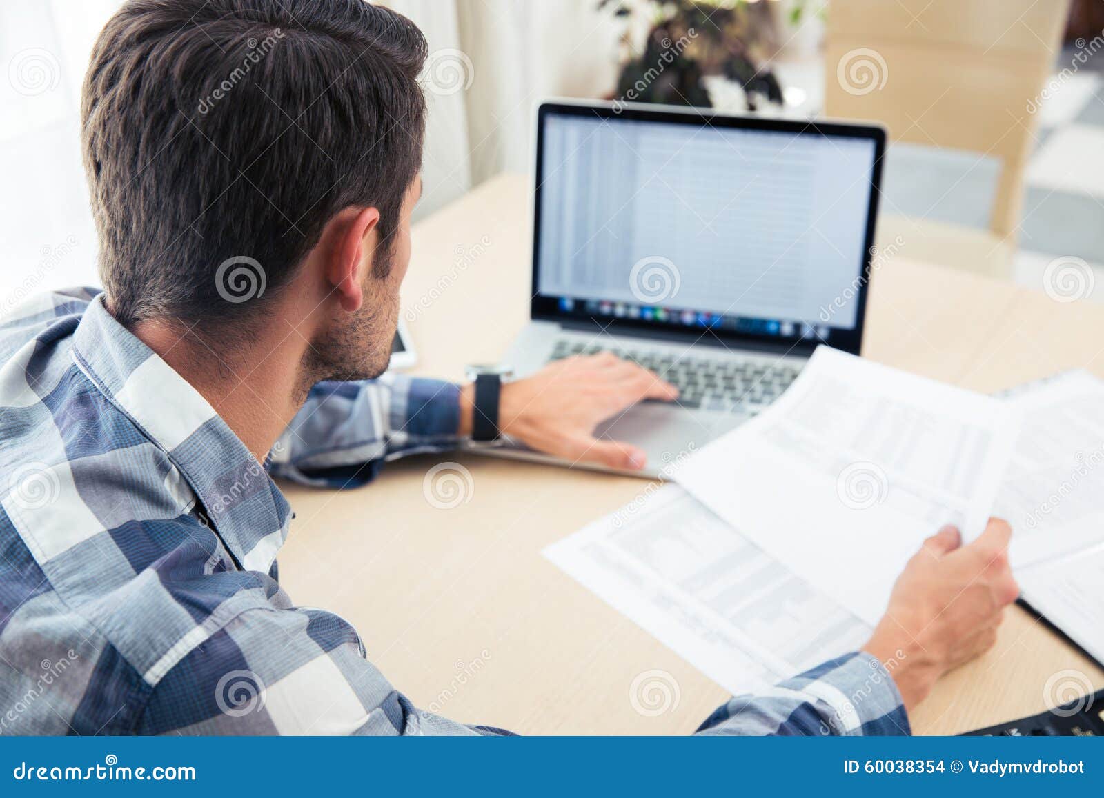 Man Sitting at the Table with Bills and Laptop Stock Photo - Image of ...