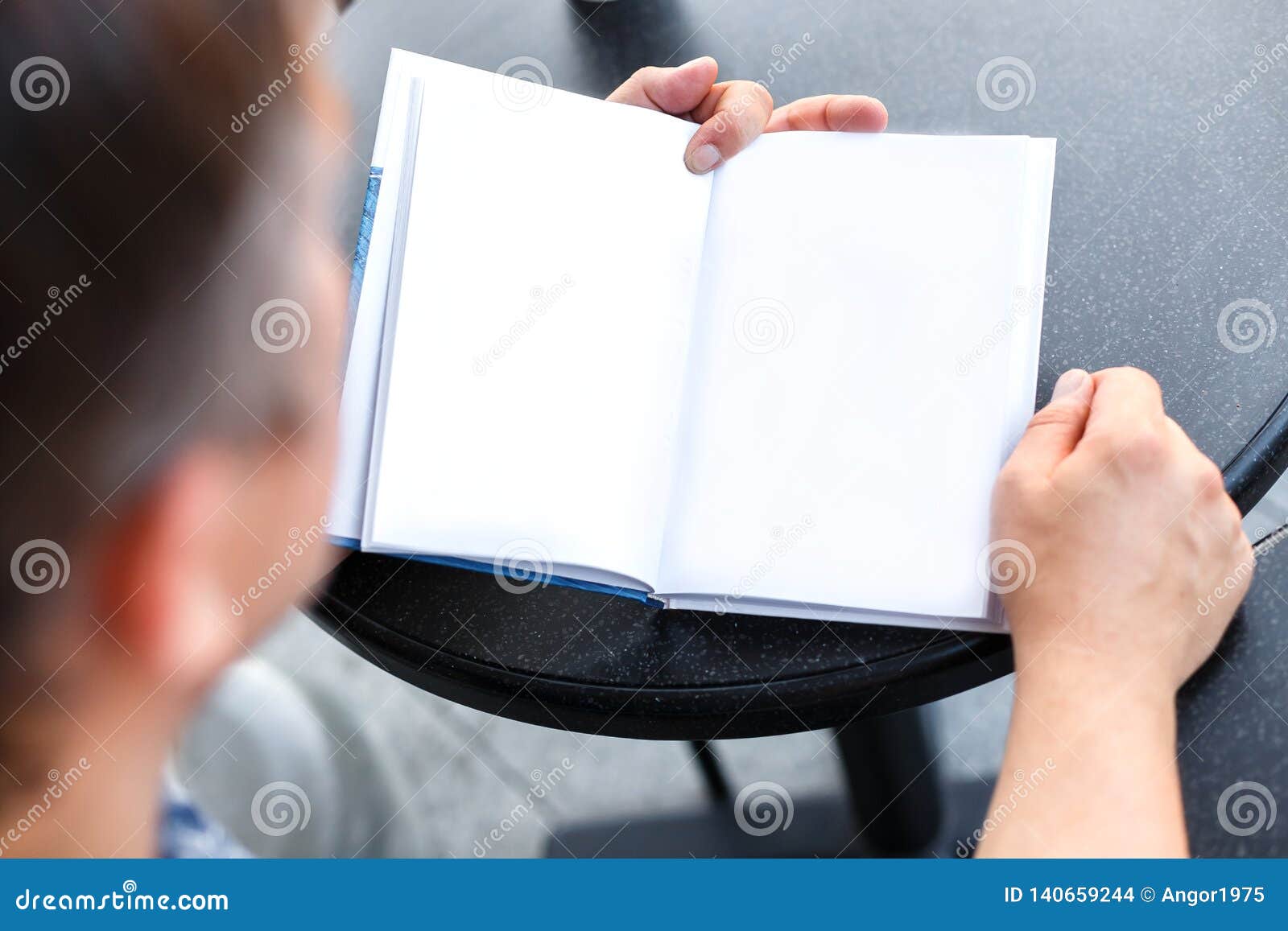 Man Sitting at the Table in Cafe, Read the Opened White Empty Book ...