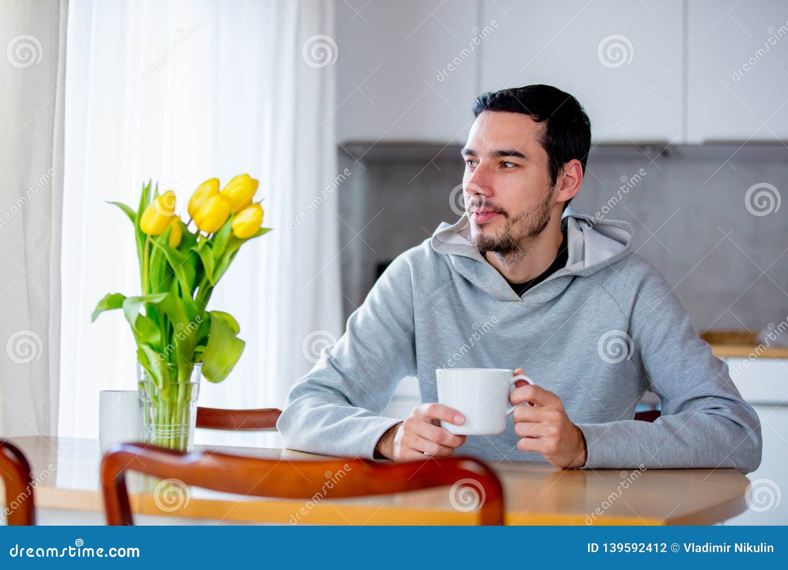 Man Sitting at Table with Cup of Coffee or Tea Stock Photo - Image of ...