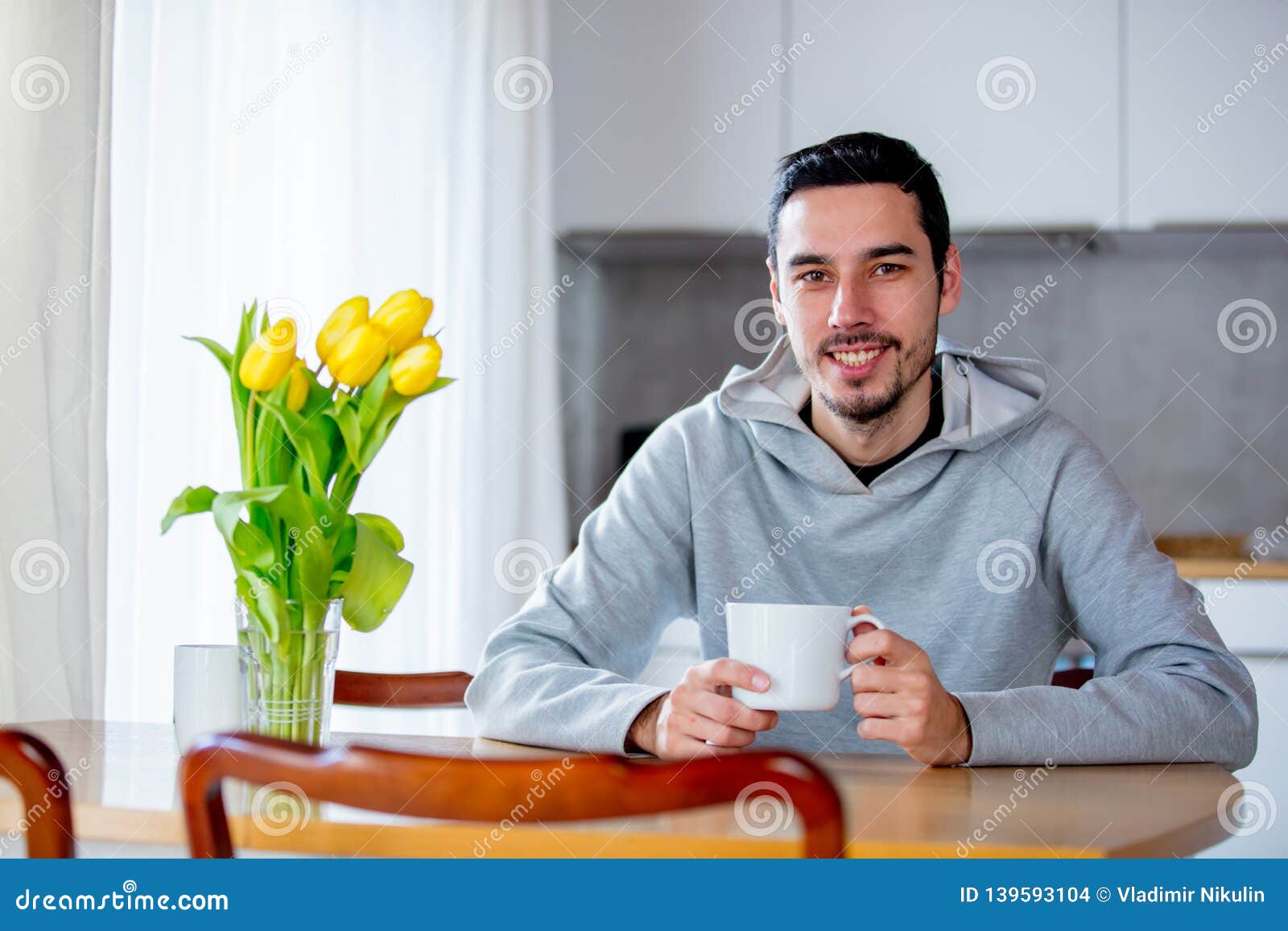 Man Sitting at Table with Cup of Coffee or Tea Stock Photo - Image of ...