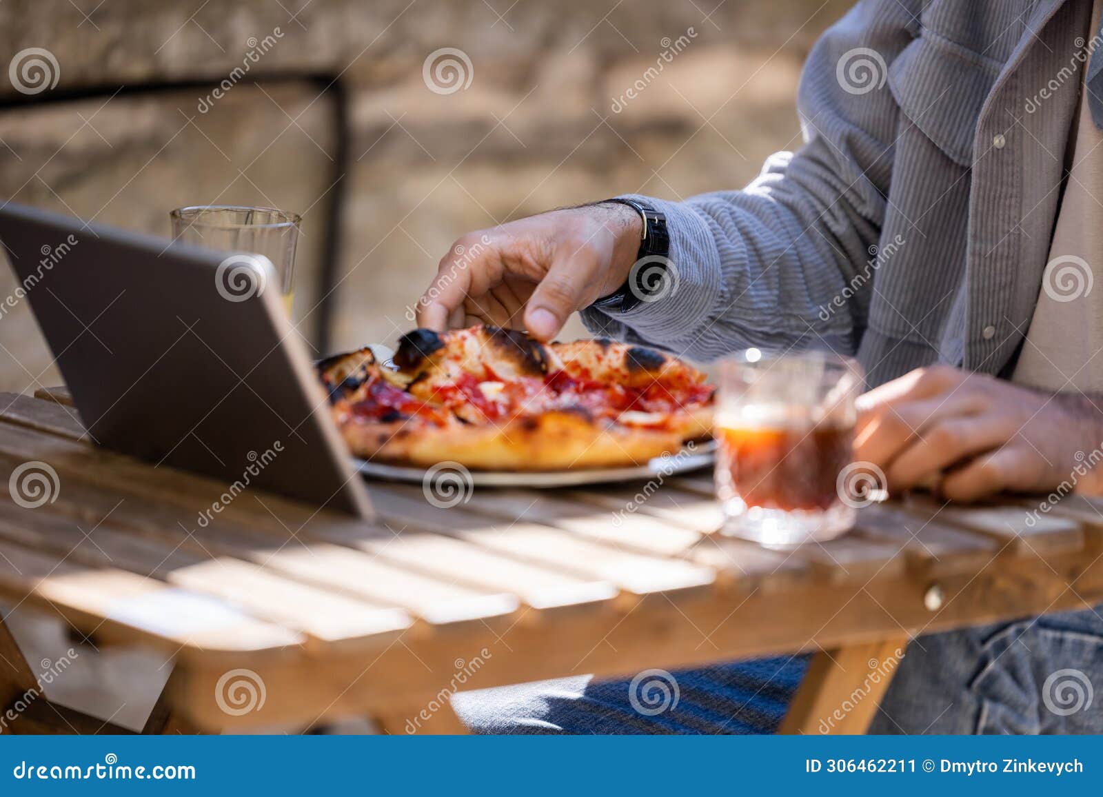Man Sitting at the Table, Eating Pizza and Working on Laptop Stock ...