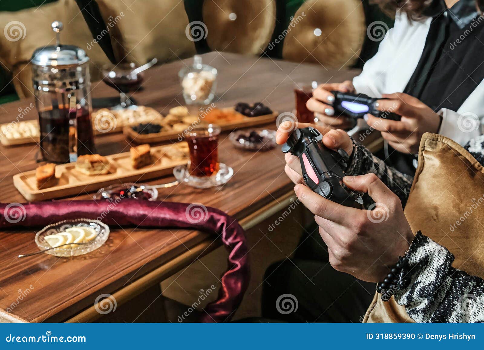 Man Sitting at Table Holding Game Controller Stock Photo - Image of ...