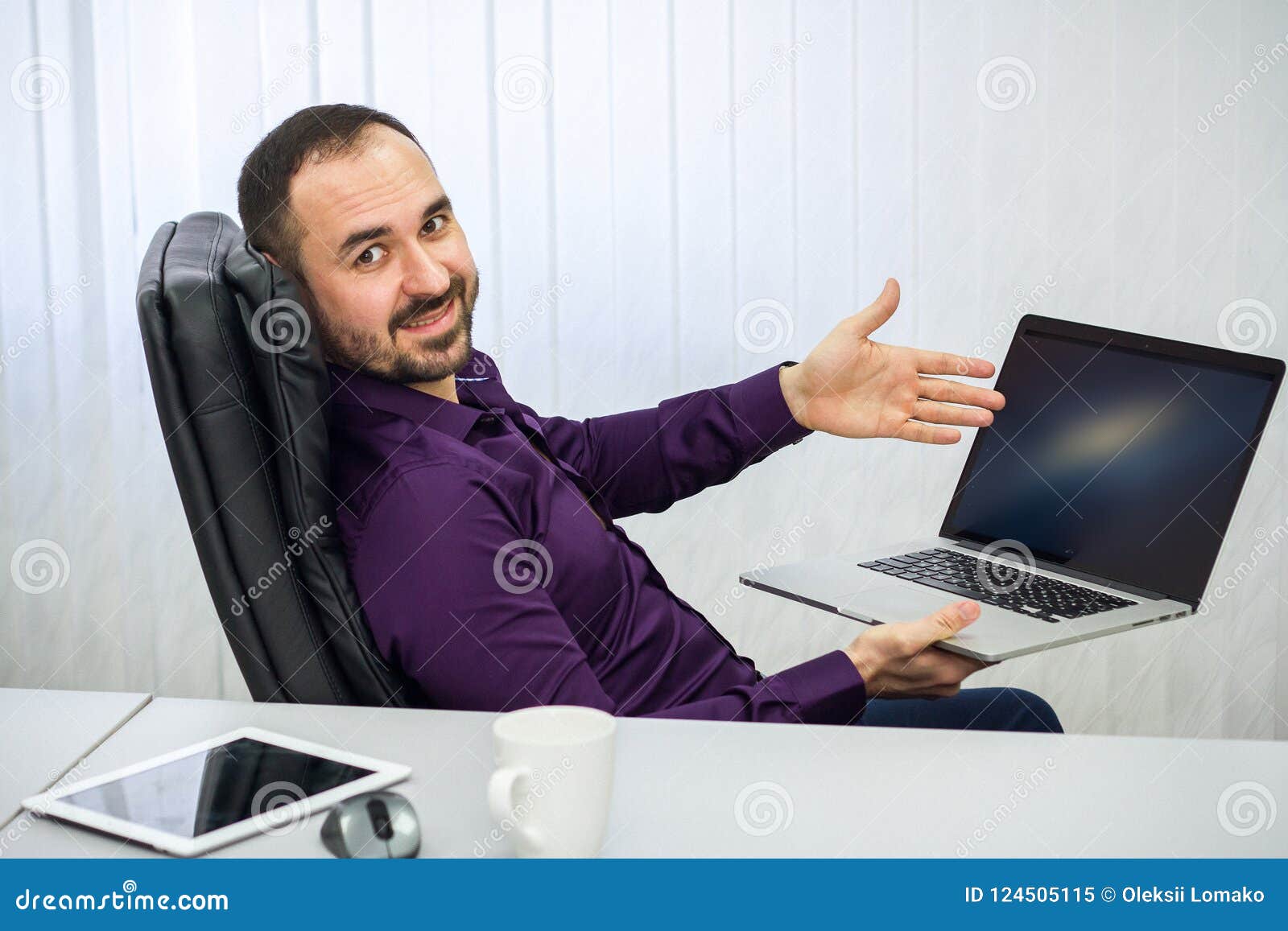 Man at the Table in the Office. on the Table a Tablet, a Cup and Stock ...