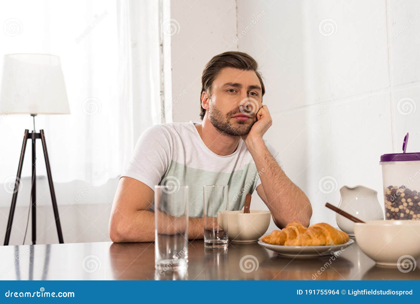 Man Sitting at Table and Propping Face with Hand during Breakfast in ...