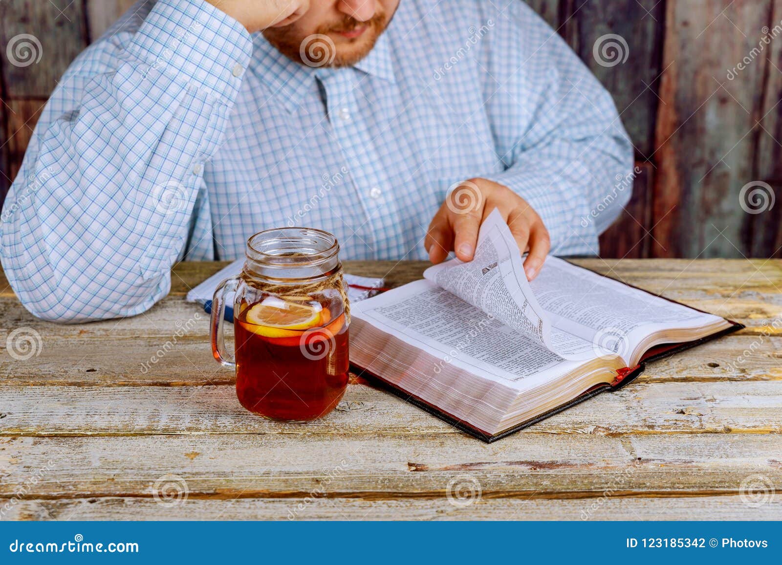 Man Sitting at a Table Reading the Bible Stock Photo - Image of human ...