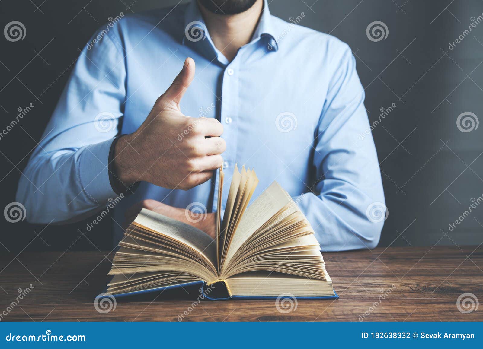 Man Sitting at a Table Reading a Book Stock Photo - Image of student ...