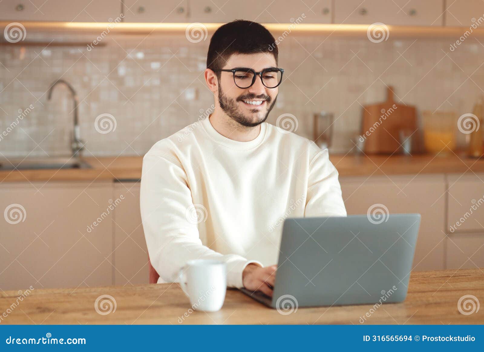 Man Sitting at Table Using Laptop Computer, Working from Home Stock ...