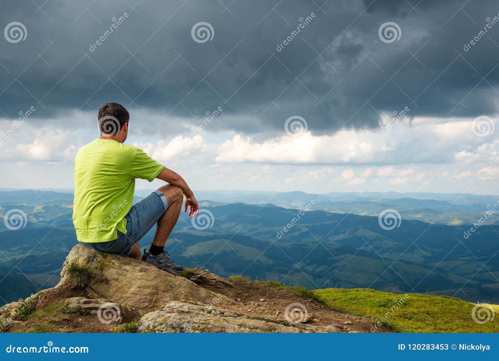 Man Sitting on the Peak of the Mountain Stock Image - Image of ...