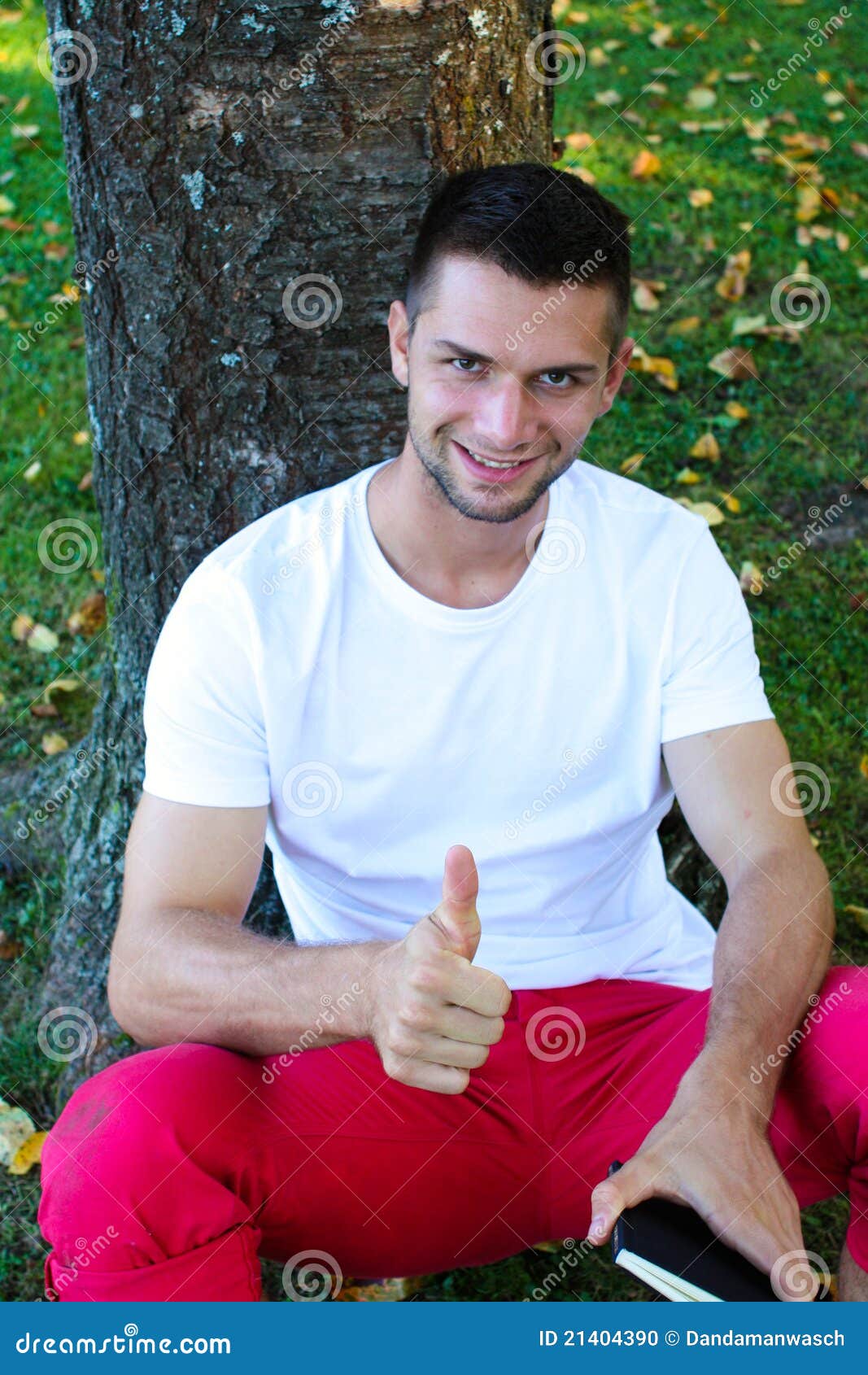 Man Sitting Under a Tree with Thumb Up and Smiling Stock Photo - Image ...