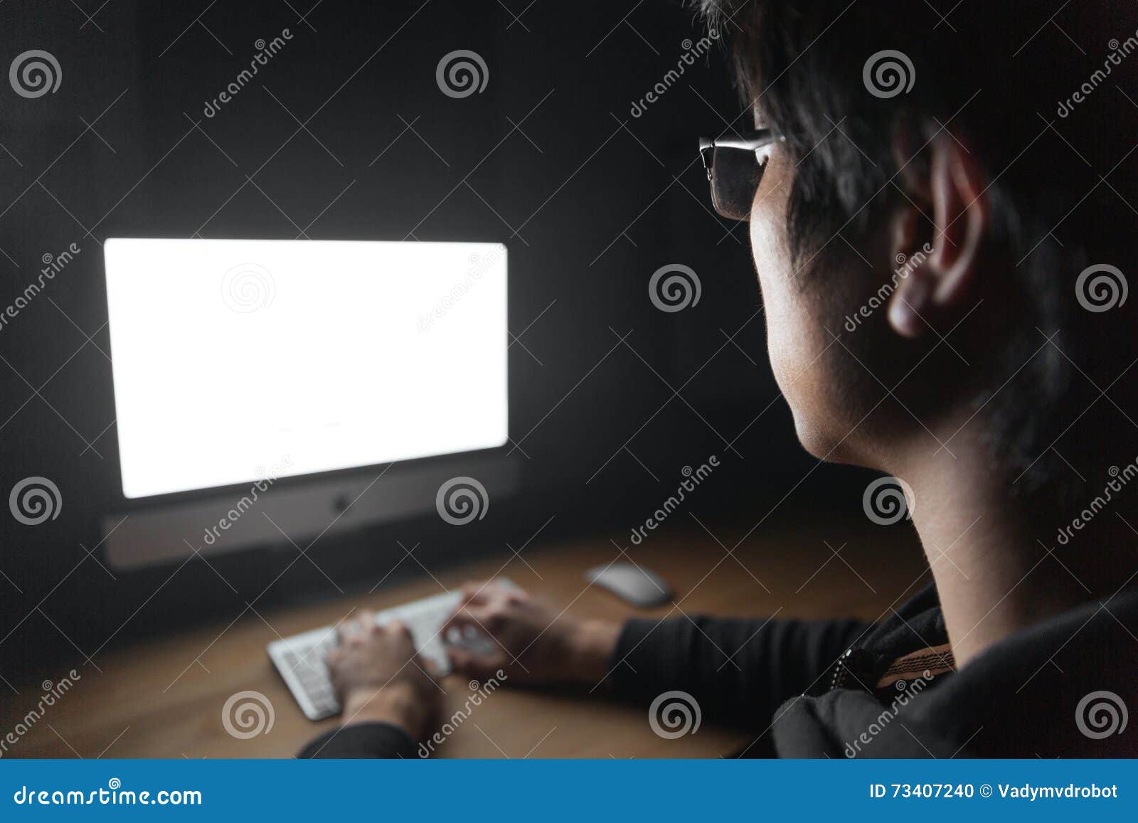 Man Sitting and Using Blank Screen Computer in Dark Room Stock Photo ...