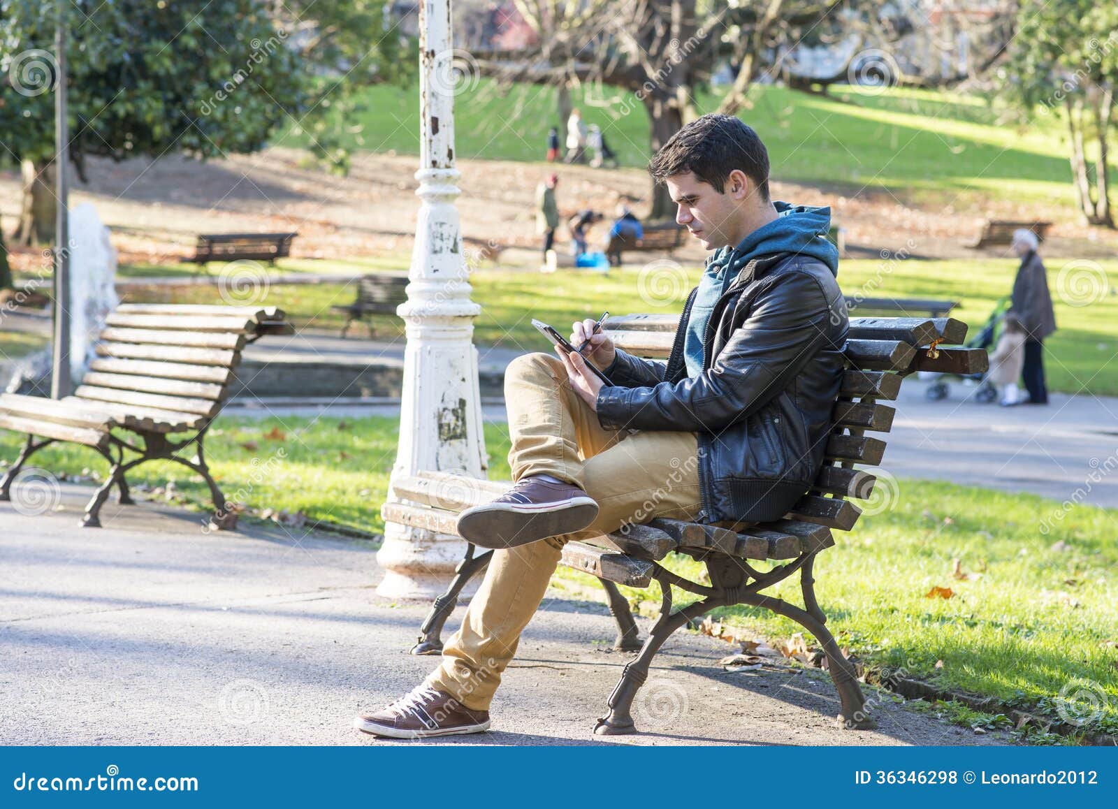 Man Sitting and Using Tablet Computer in the Park. Stock Photo - Image ...