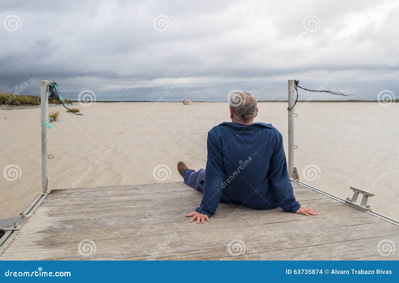 Man Sitting on Wooden Pier Facing the River Thinking Stock Photo ...